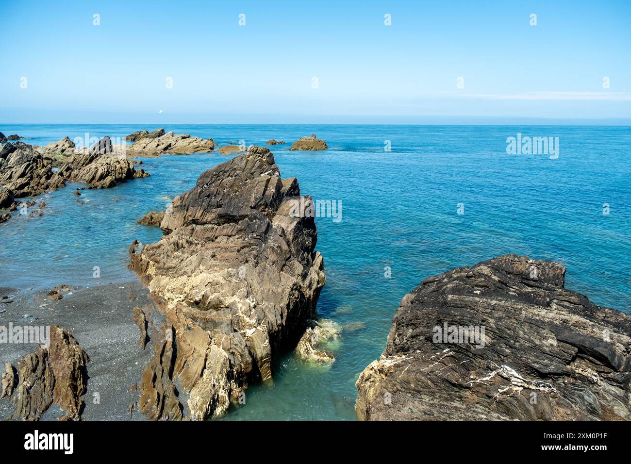 View across the rocky bay from Capstone Hill in the Devonshire town of ...