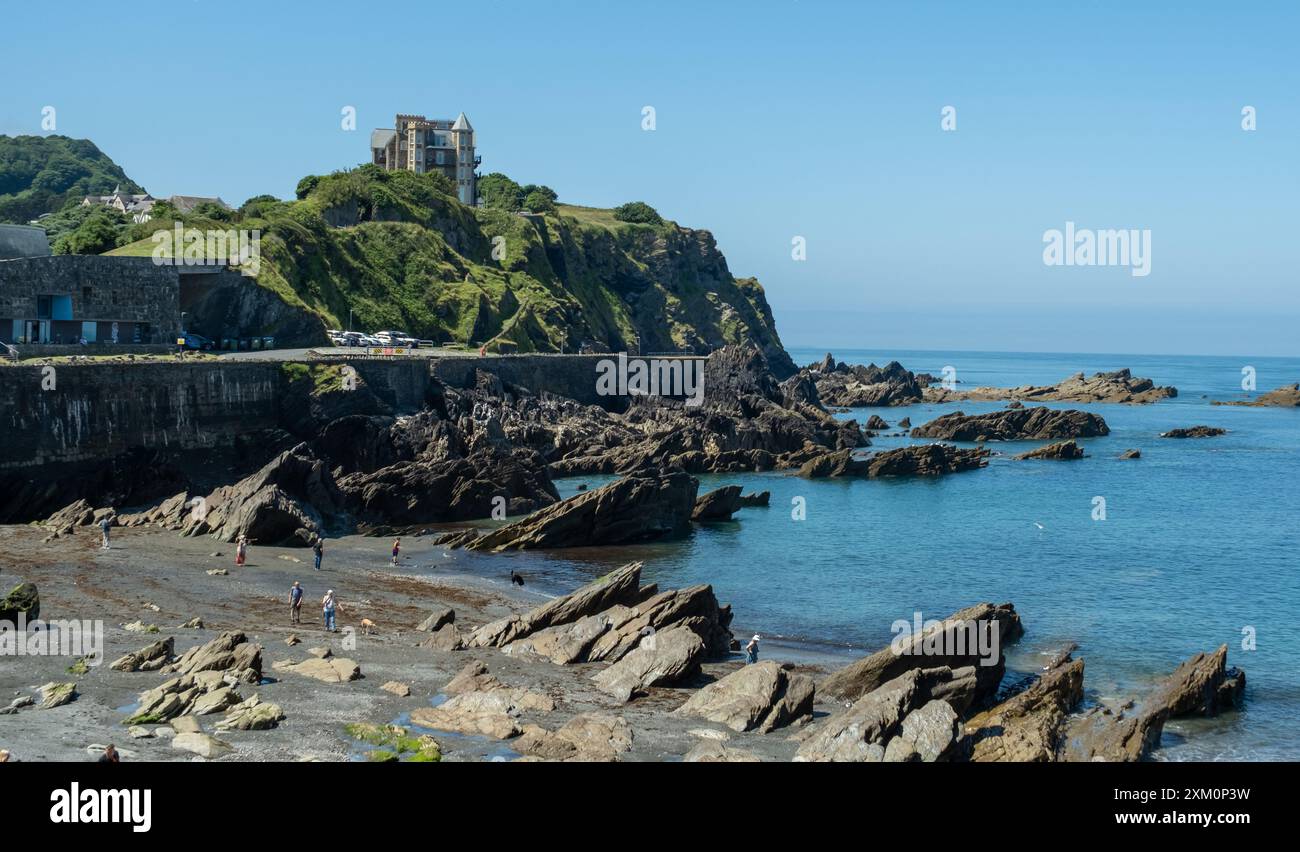 View across the rocky bay from Capstone Hill in the Devonshire town of ...