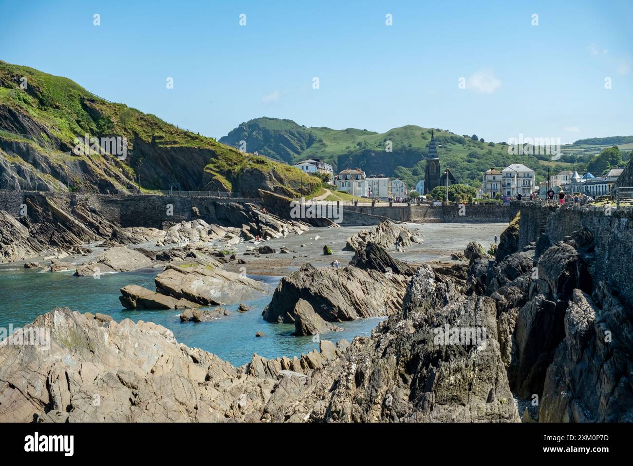View across the rocky bay from Capstone Hill in the Devonshire town of ...