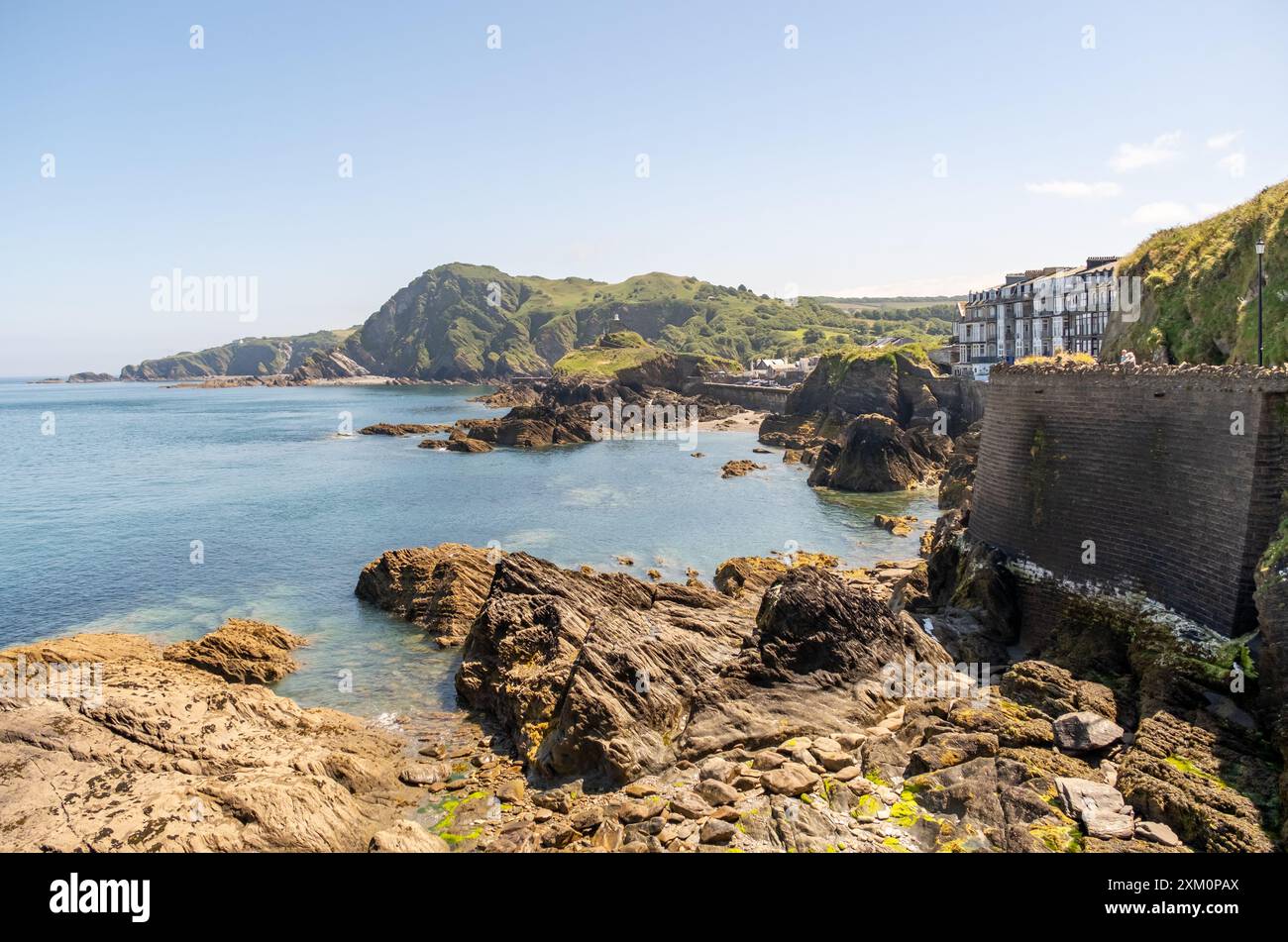 View across the rocky bay from Capstone Hill in the Devonshire town of ...