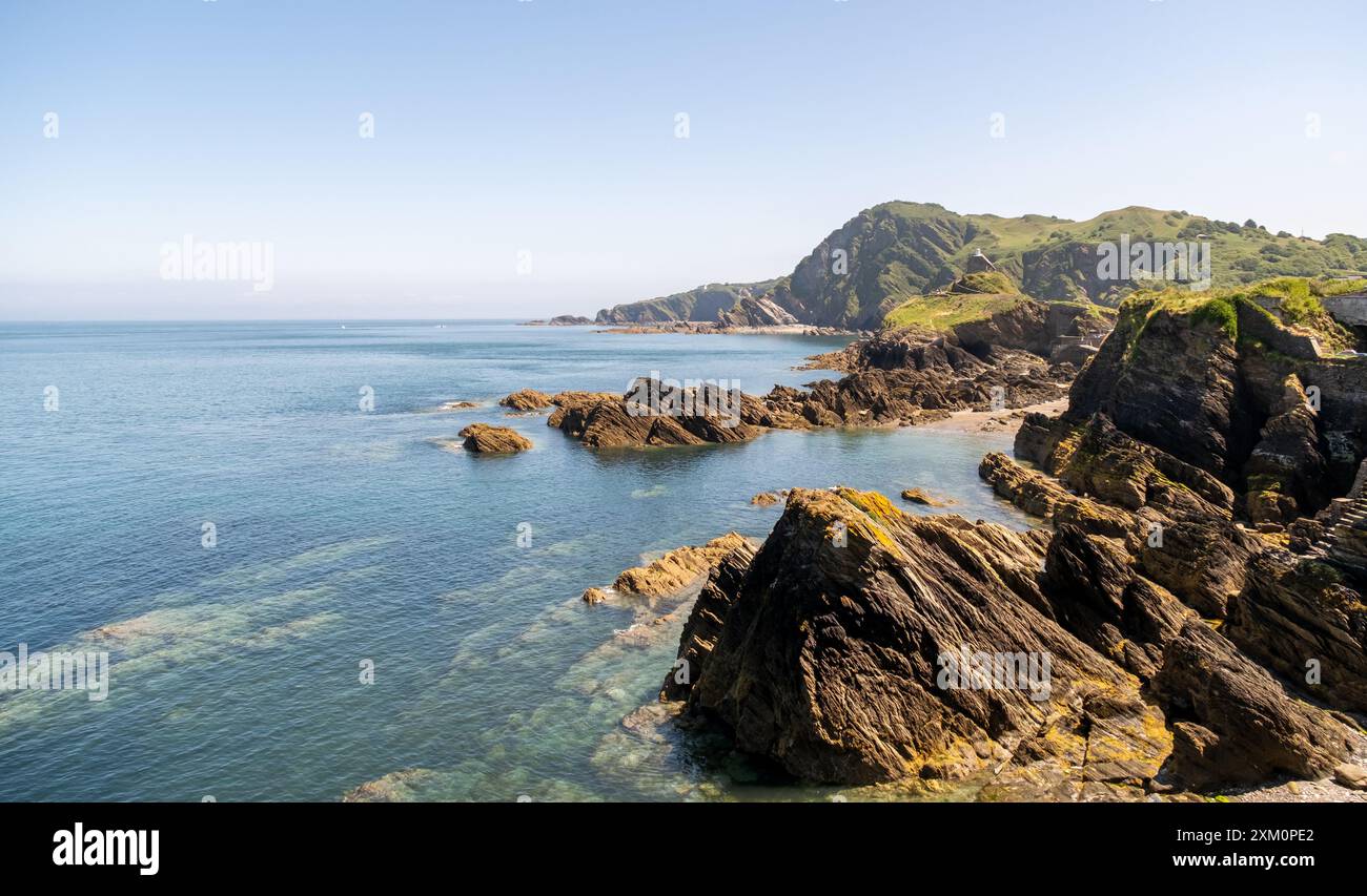 View across the rocky bay from Capstone Hill in the Devonshire town of ...