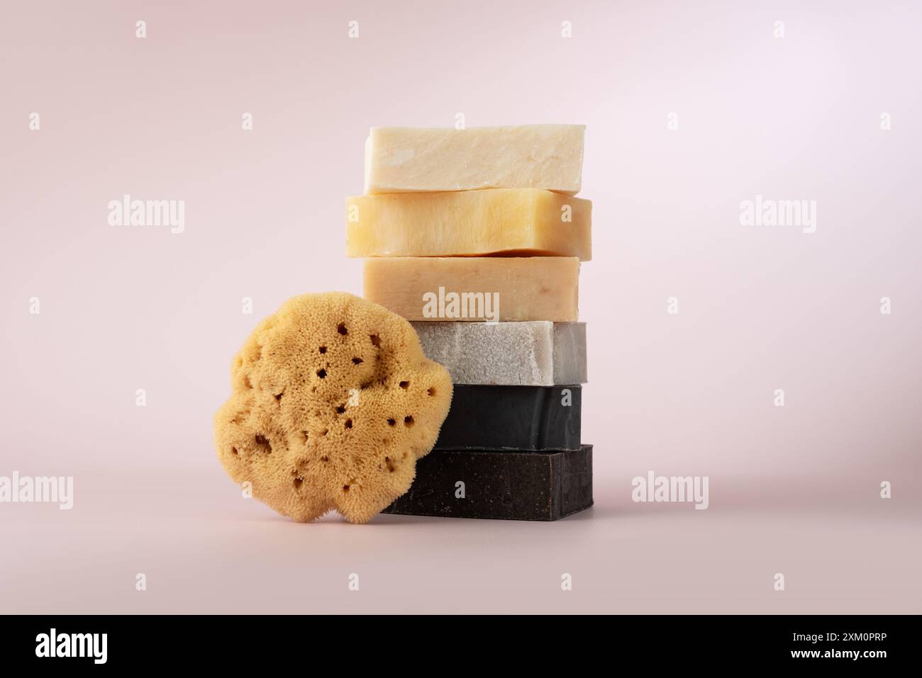 A stack of soap bars and a natural sea sponge. Organic soap bars are of ...