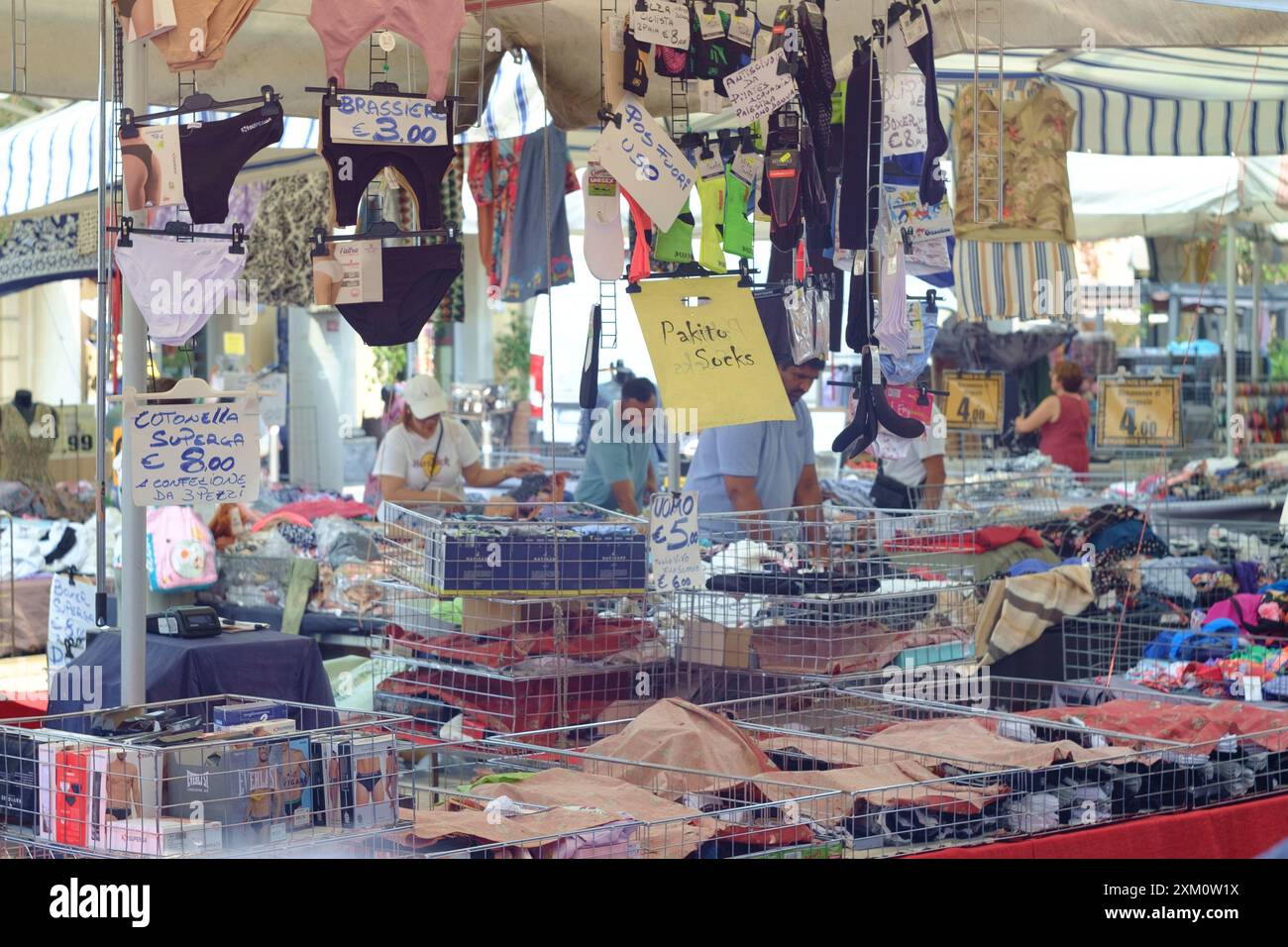Parma, Italy July 24th 2024 Customers browsing through clothes for sale ...
