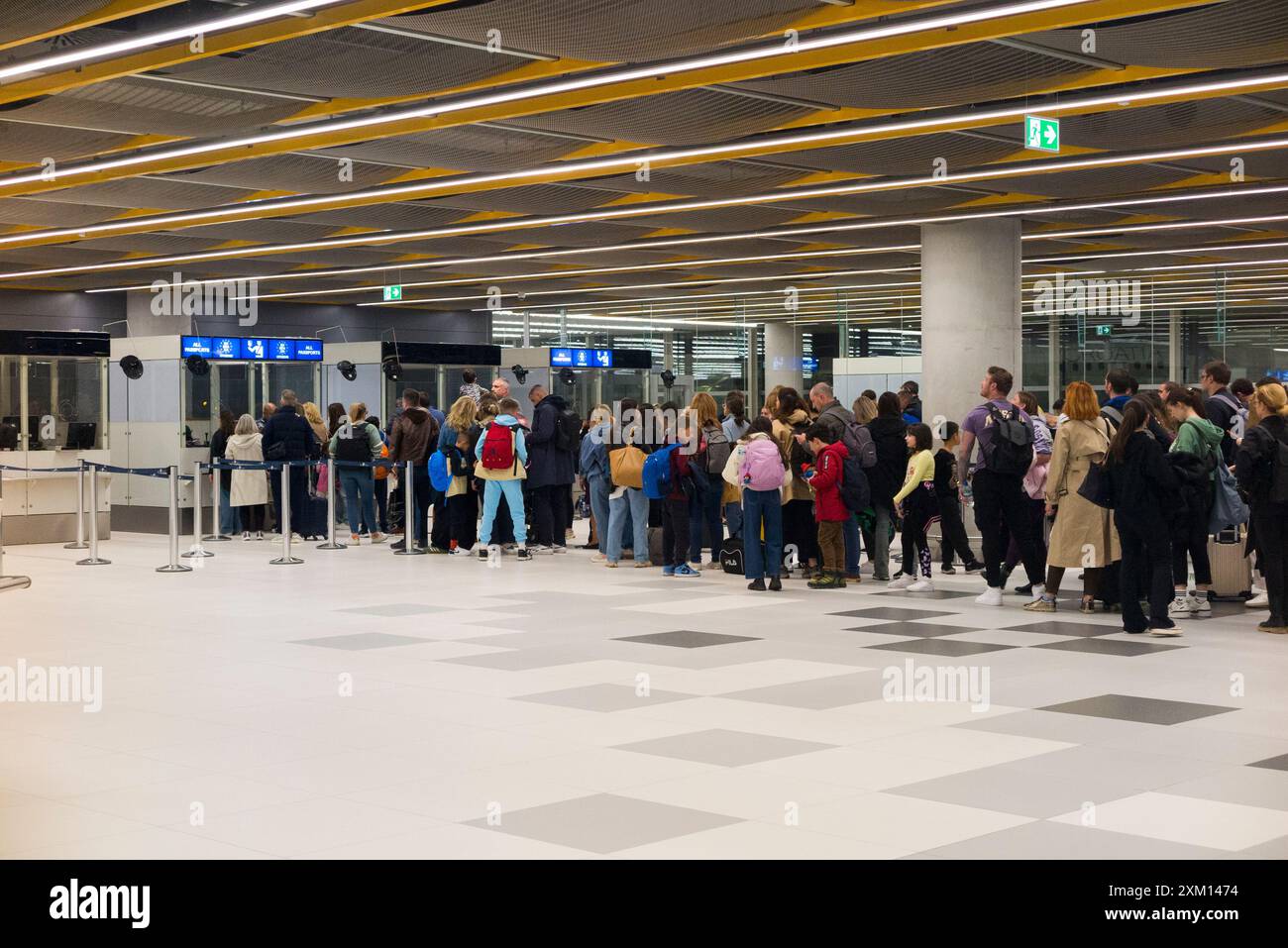 Arriving passengers, mainly tourists on holiday, at arrivals queue to ...