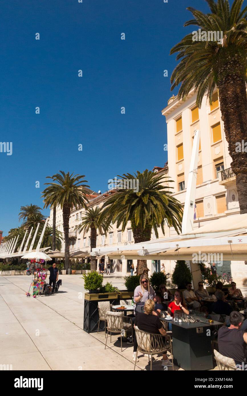 View with palm trees above restaurant cafe on the promenade following ...