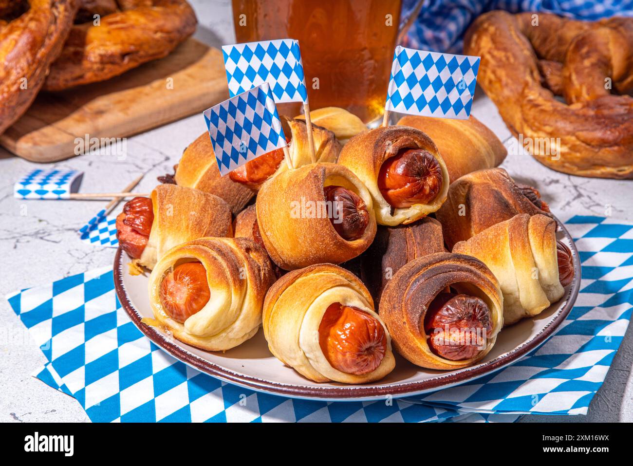 Oktoberfest party food. Pretzel hot dogs, puff pastry rolls with ...