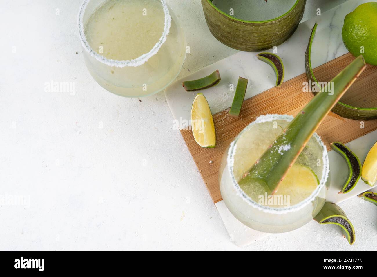 Aloe margarita cocktail with salty rim, lime and aloe vera slices ...