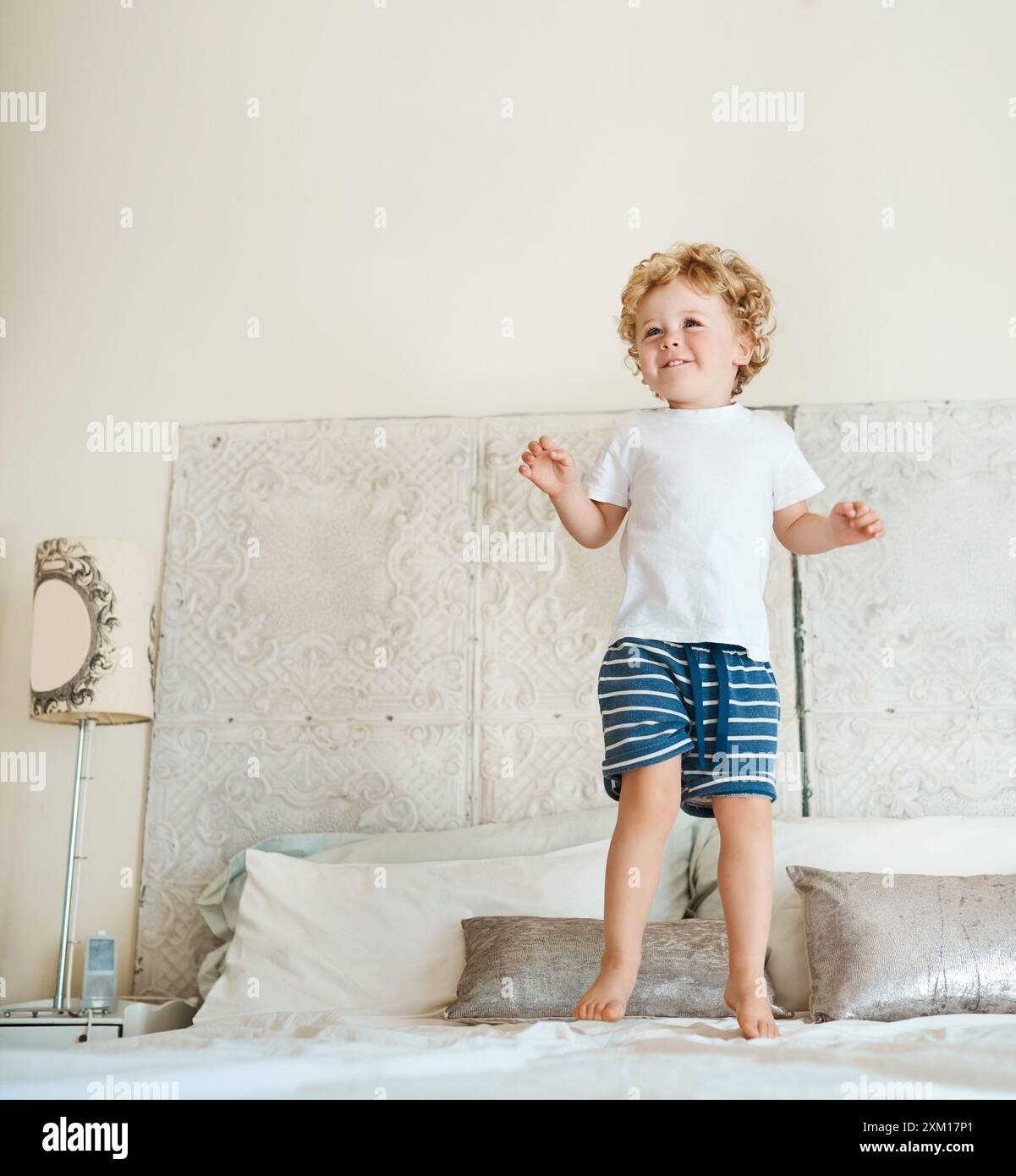 Happy, child and jump on bed for fun with energy, coordination balance ...