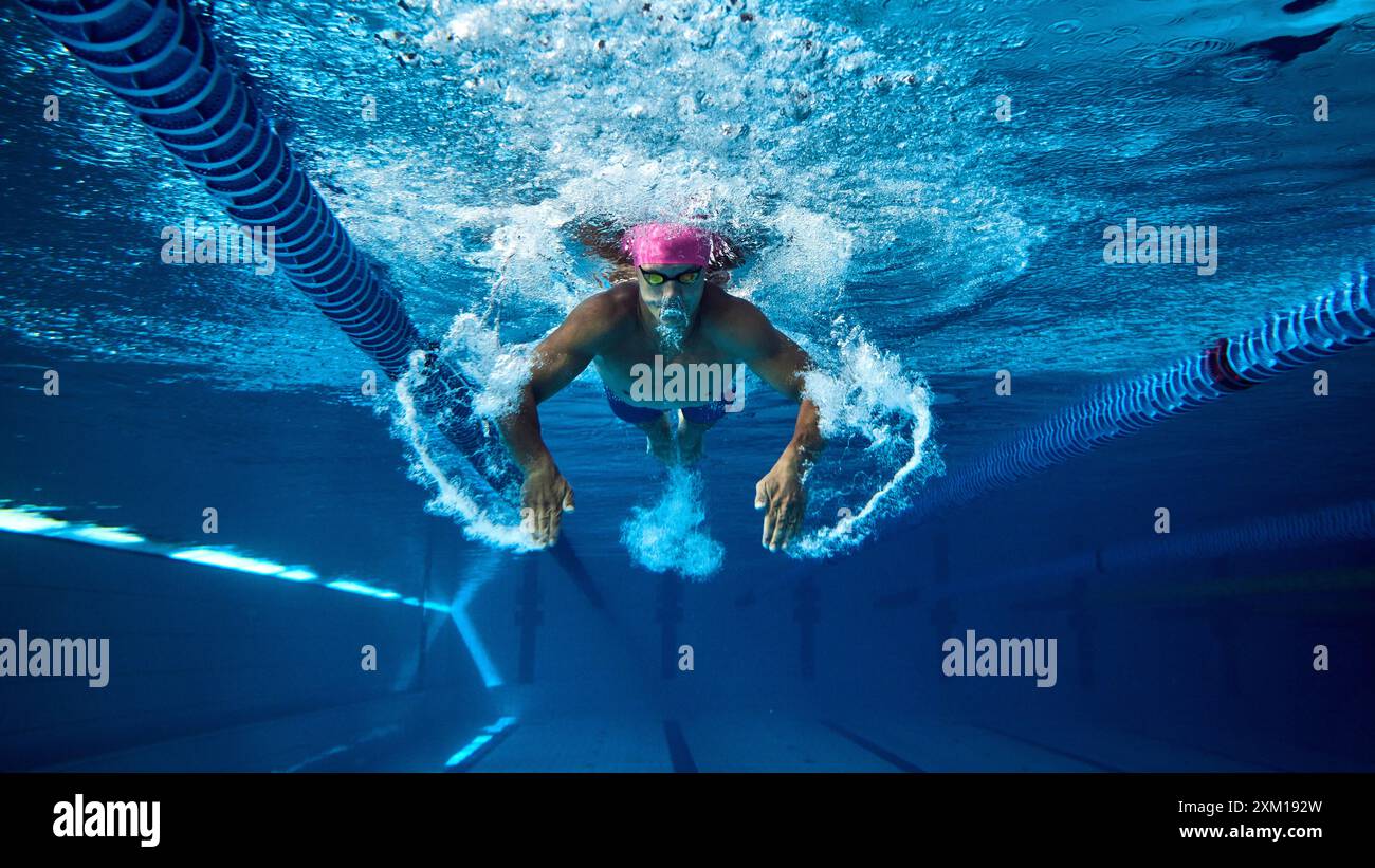 Competitive swimmer, man with athletic physique captured underwater ...