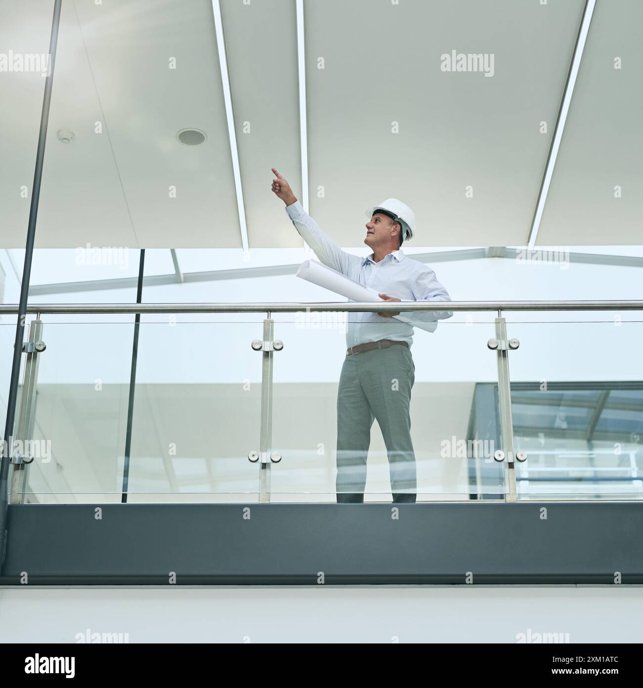 Blueprint, man and architect pointing at construction site for office ...