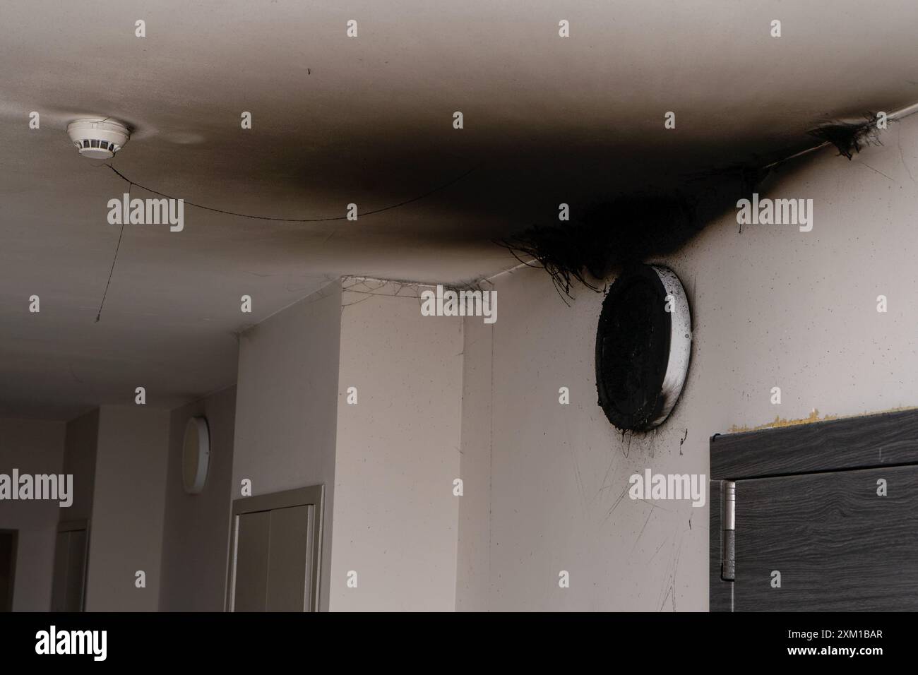 Burnt out LED lamp. A lampshade lamp on the wall after a fire ...