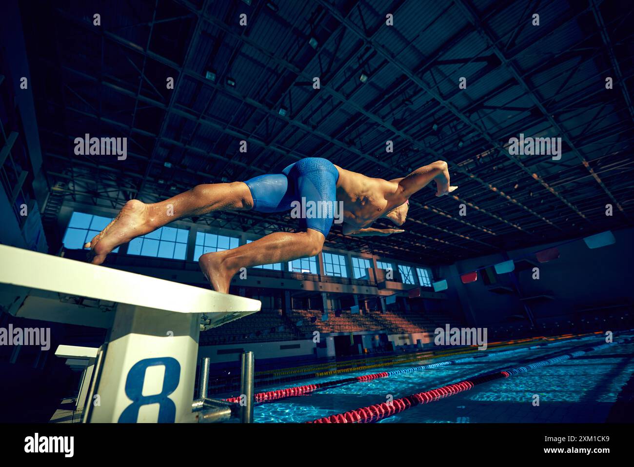 Dynamic photo of young muscular man, professional swimmer diving into ...