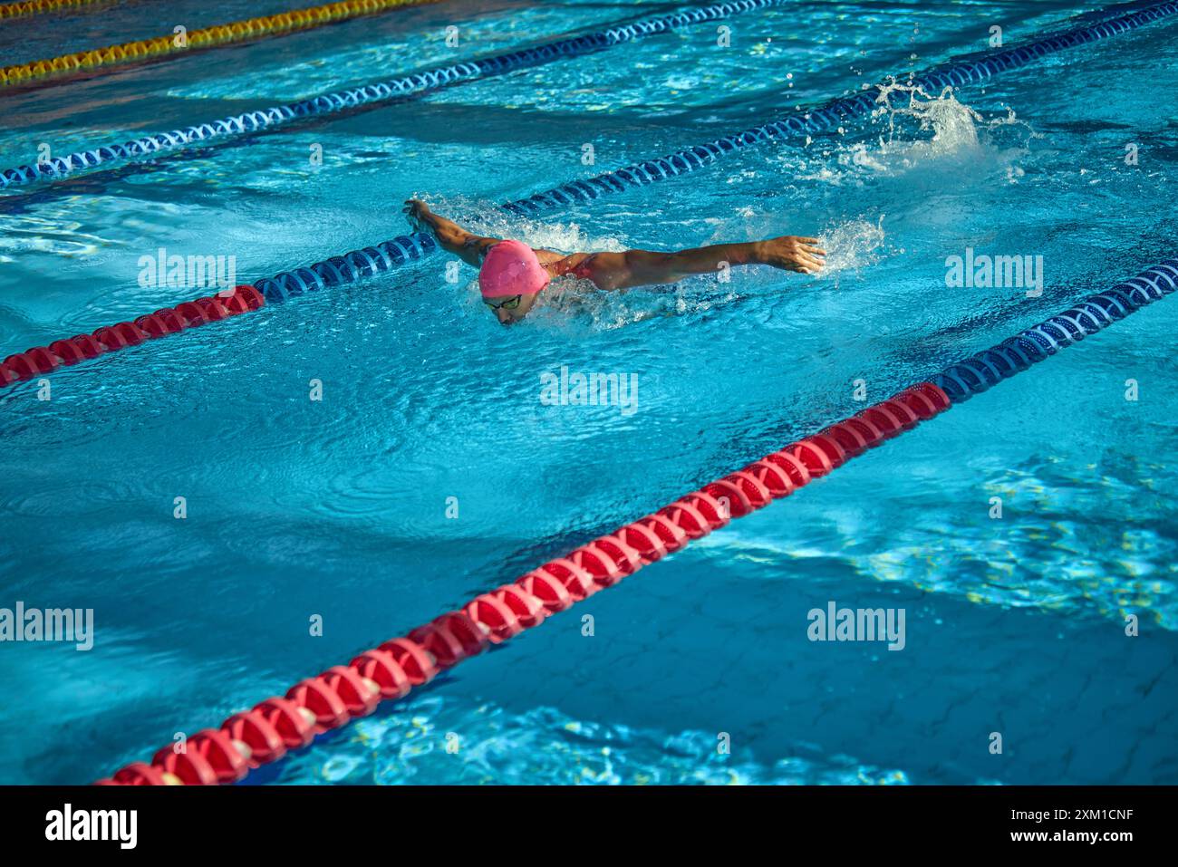 Side view of swimmer glides powerfully through water with butterfly ...