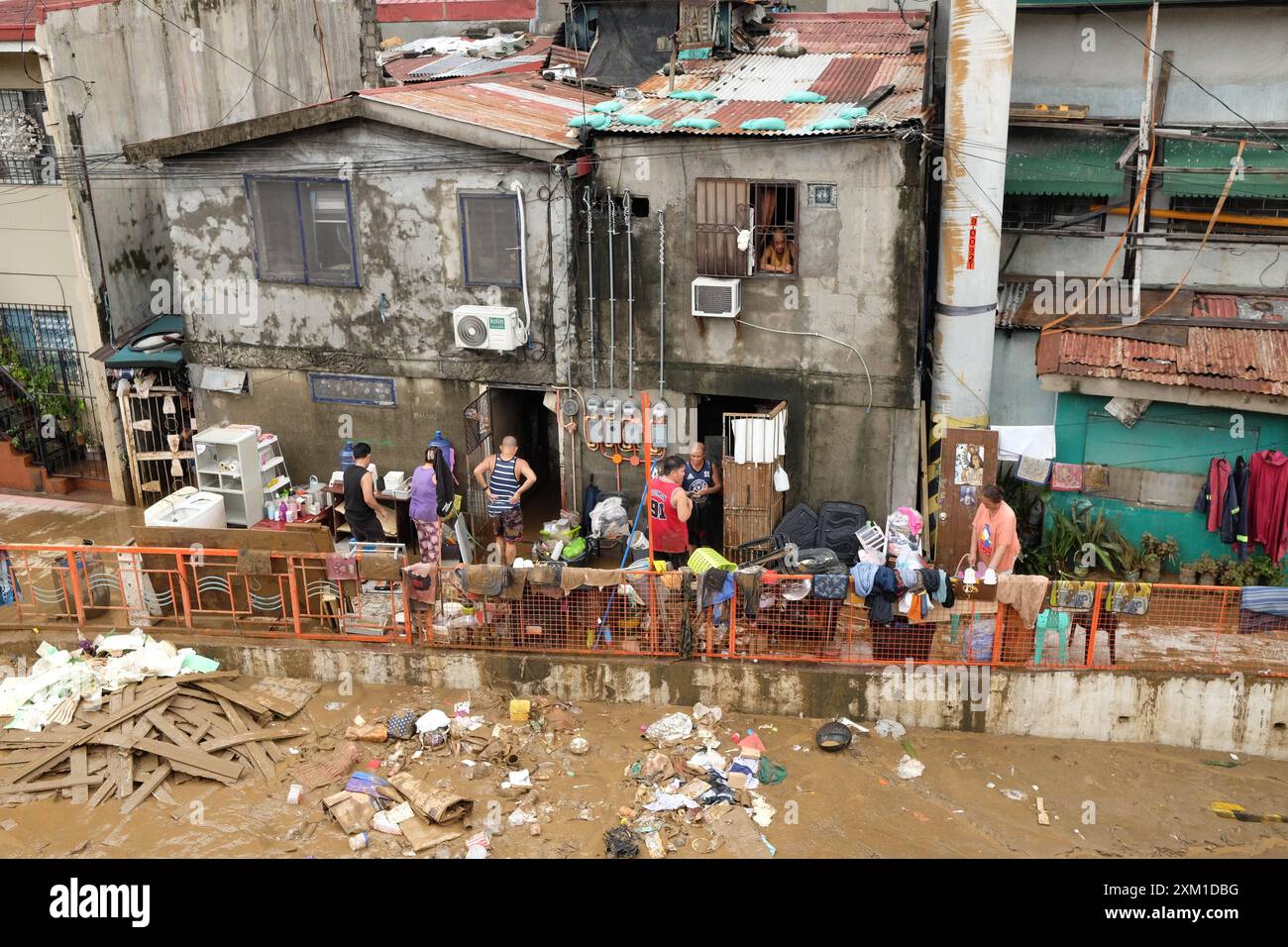 On July 25, 2024, residents of Marikina, Philippines, clean their homes ...