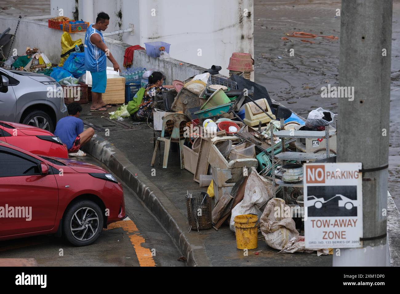 On July 25, 2024, residents of Marikina, Philippines, clean their homes ...