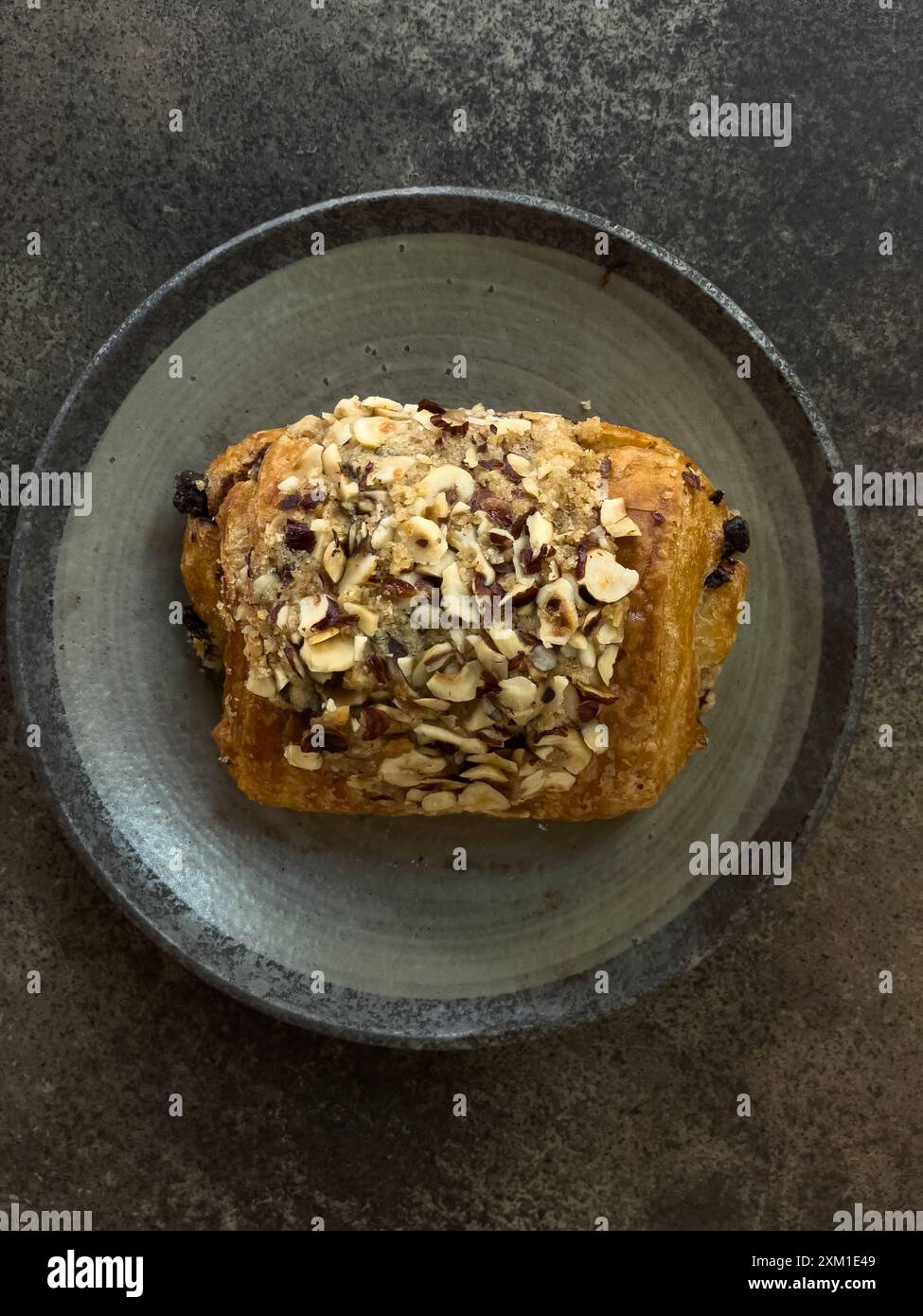 Iced coffee and freshly baked pastry on rustic ceramic. Dark background ...