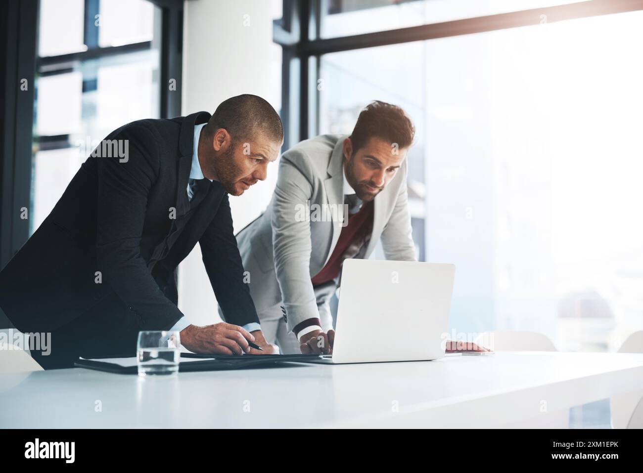 Businessmen, laptop and planning for problem solving in office, accounting agency and teamwork ...