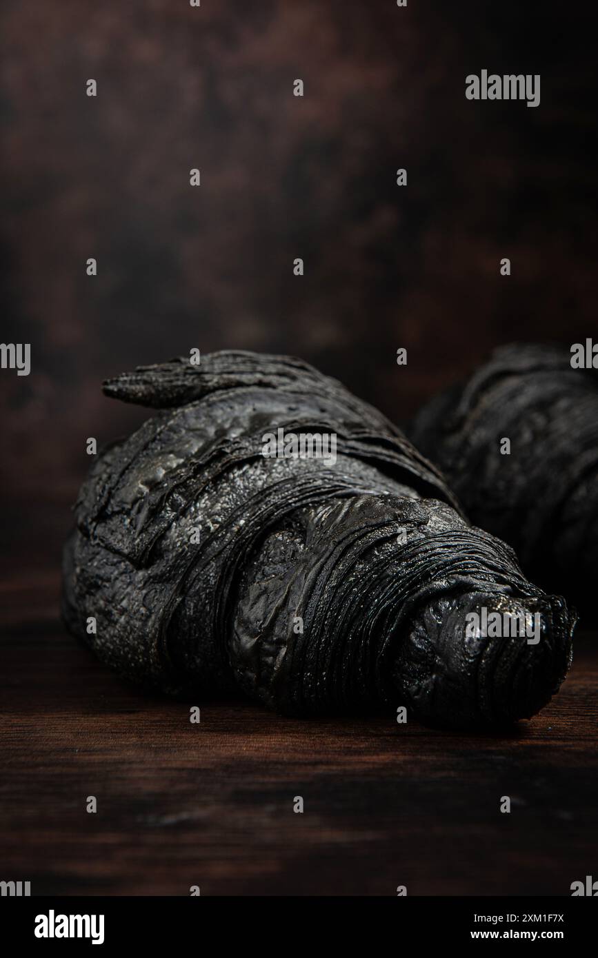 Black gourmet croissants on a black background. Vertical top view Stock ...