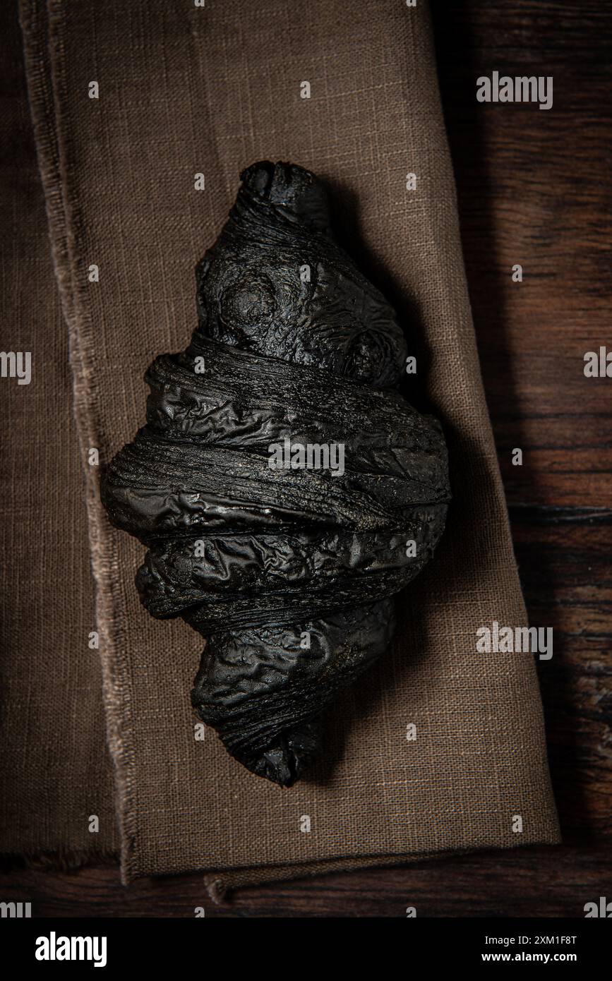 Black gourmet croissants on a black background. Vertical top view Stock ...