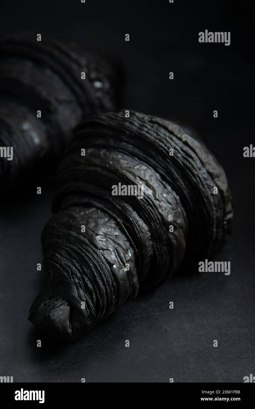 Black gourmet croissants on a black background. Vertical top view Stock ...