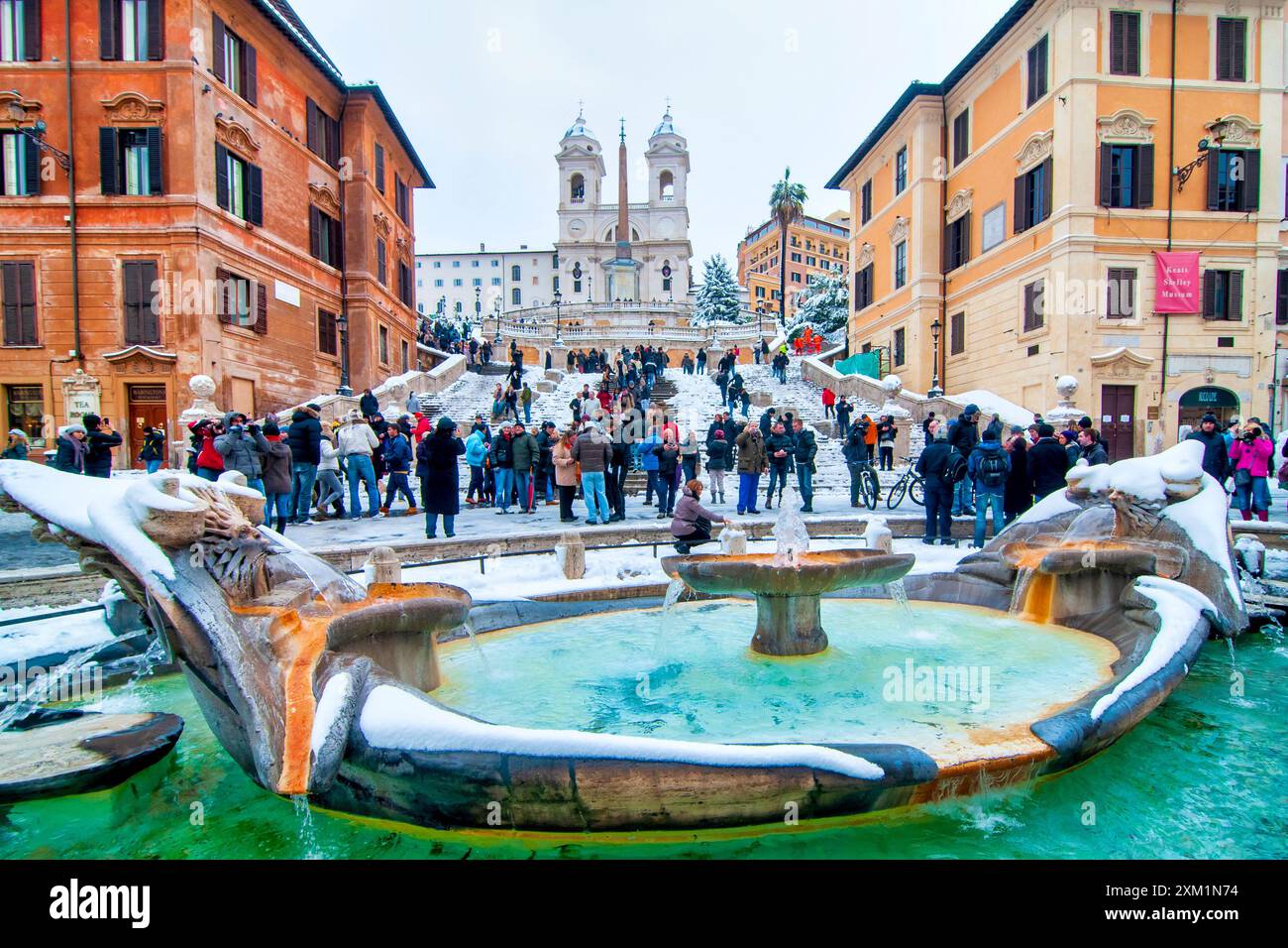 View of the snow-covered Fontana della Barcaccia in Piazza di Spagna ...