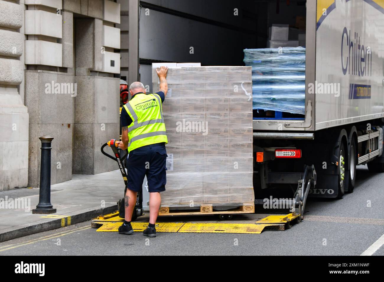 London, England, UK - 27 June 2023: Lorry driver unloading a pallet of ...
