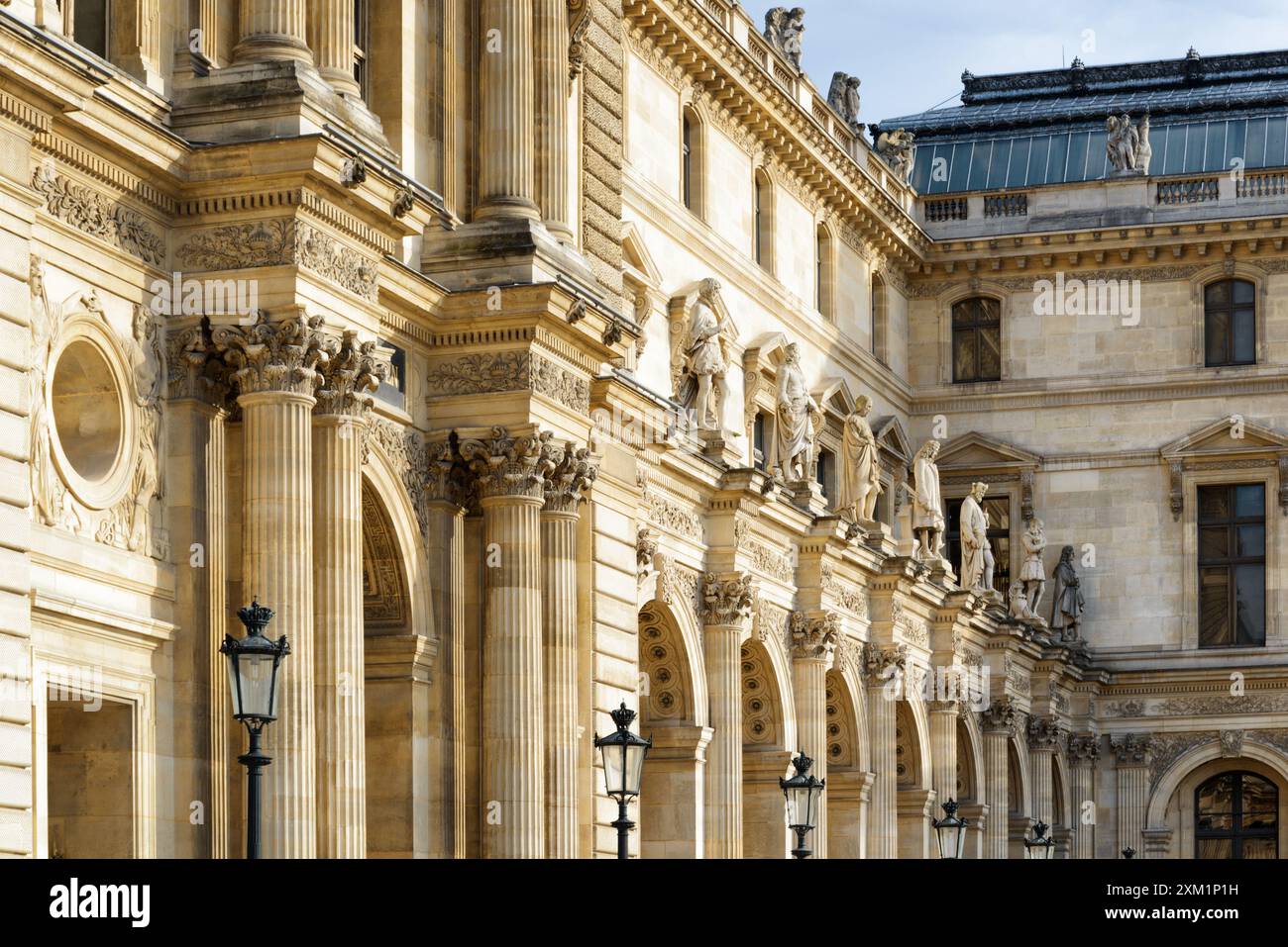 Columns and sculptures that adorn the facade of the Louvre in Pa Stock ...