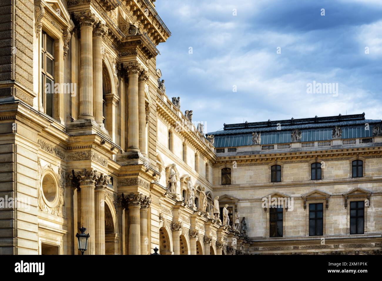 Columns and sculptures that adorn the facade of the Louvre in Pa Stock ...