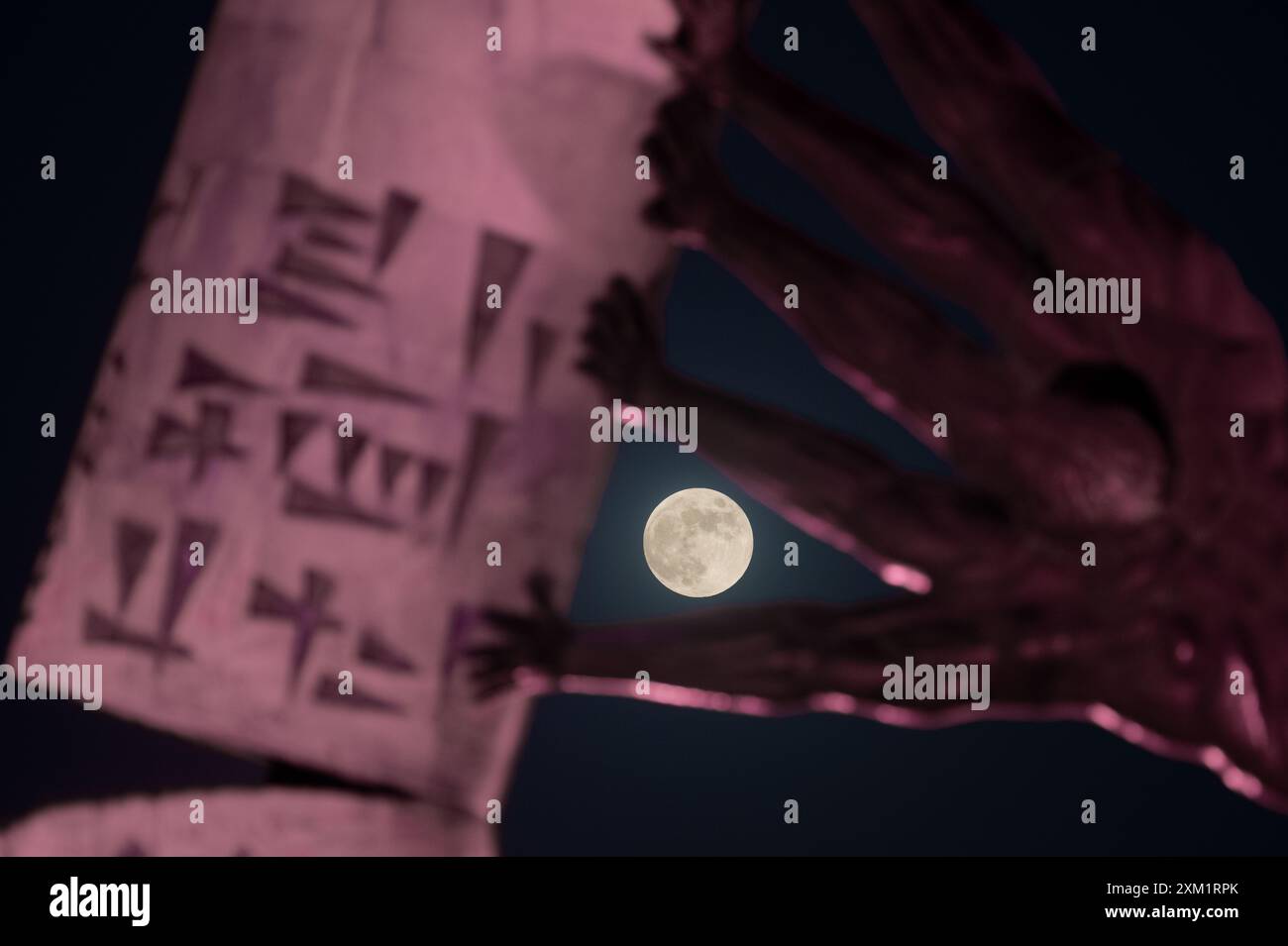 Full Hunter's Moon rising behind the "Save Iraqi Culture" Monument in ...