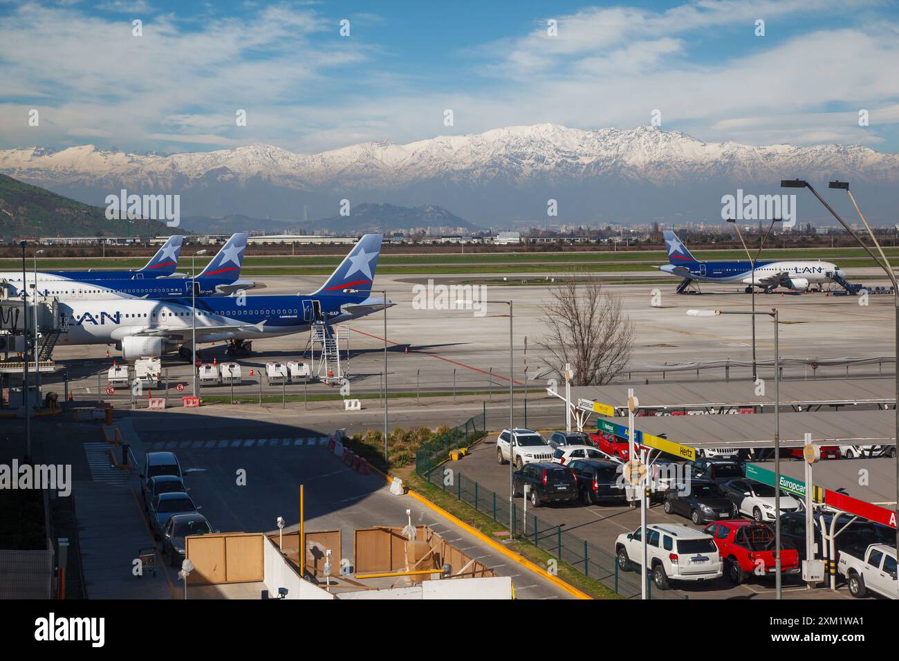 The Andes mountains covered with snow and LAN airplanes parked in ...