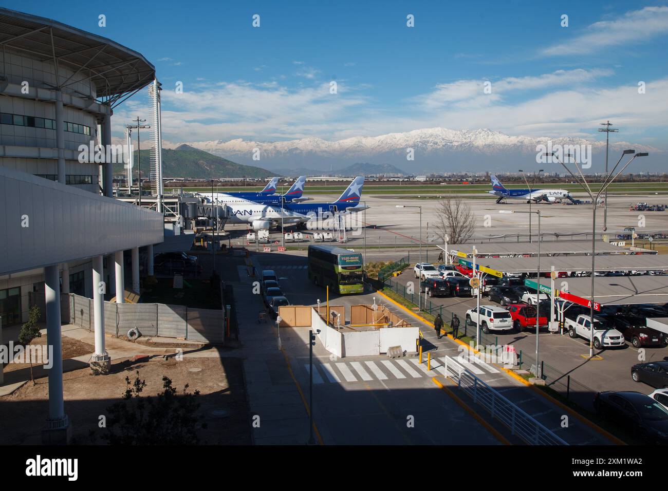 The Andes mountains covered with snow and LAN airplanes parked in ...