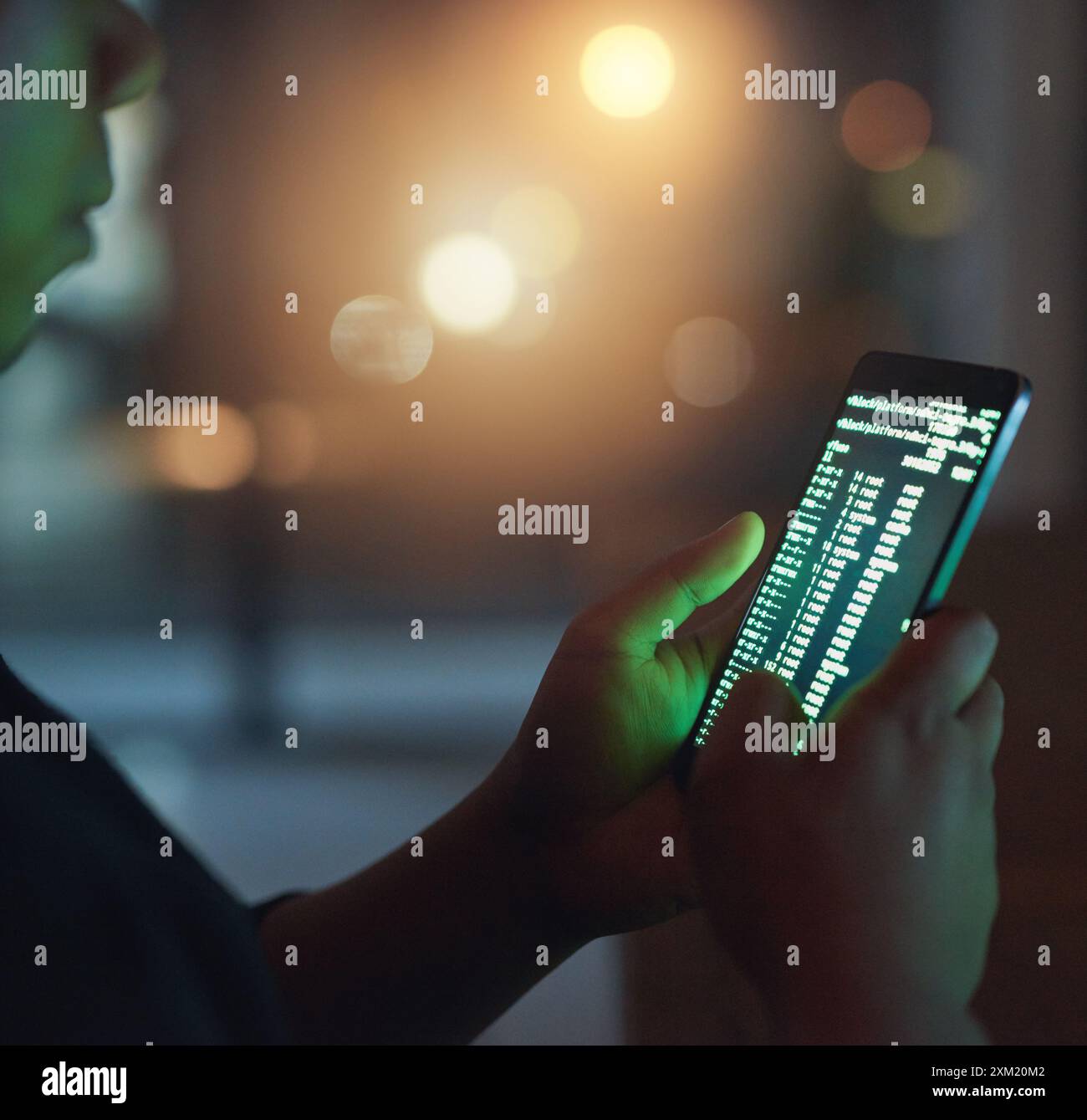 Hands, code and hacker with phone screen for cyber attack, fraud or data breach with bokeh at ...