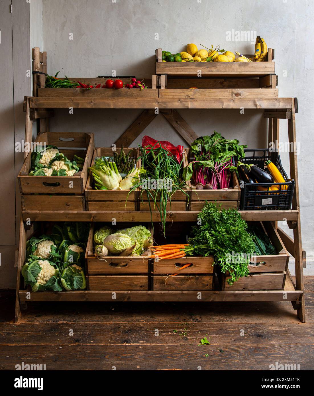 Wooden box of farm fresh vegetables. Display stands with wooden boxes ...