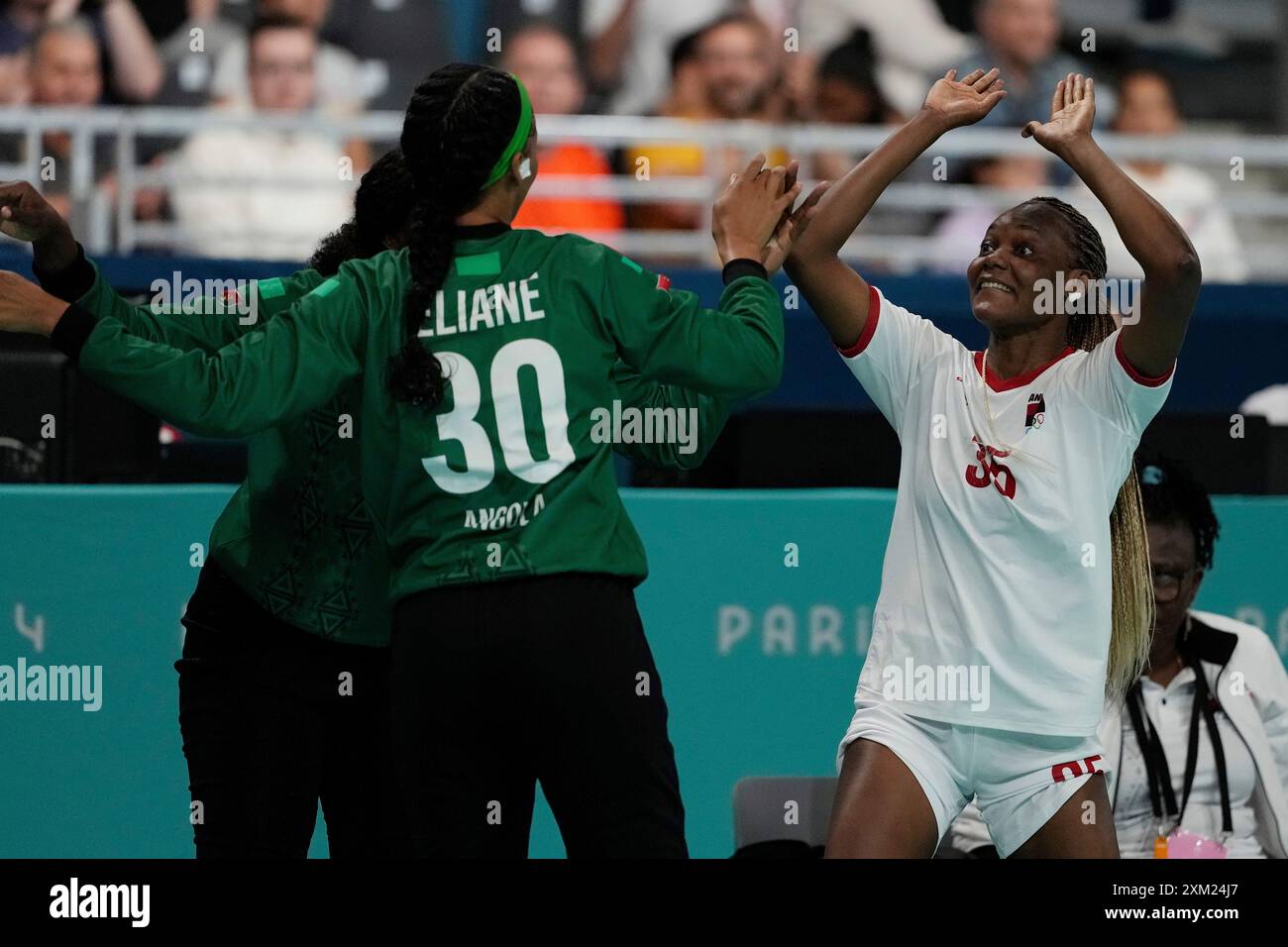 Azenaide Carlos and Eliane Paulo, of Angola, celebrate a goal during the women's handball ...