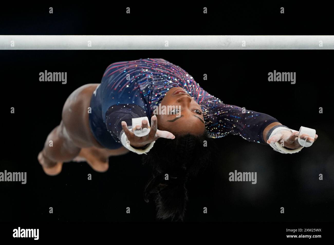 Simone Biles of the United States practices the uneven bars during a ...