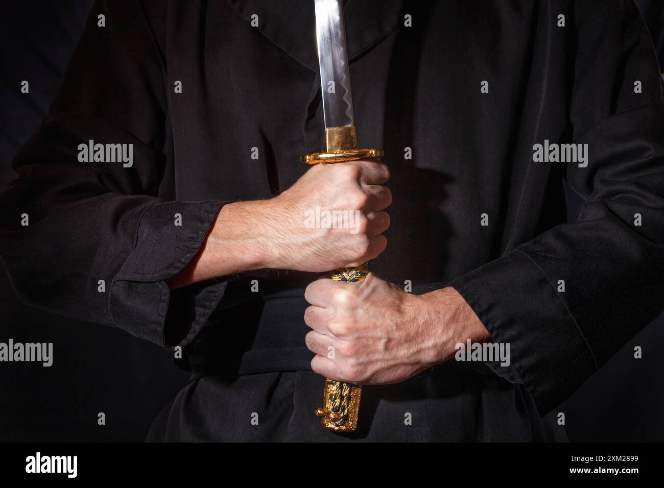 Samurai ready for battle holding a Japanese katana sword. Photo of a ...