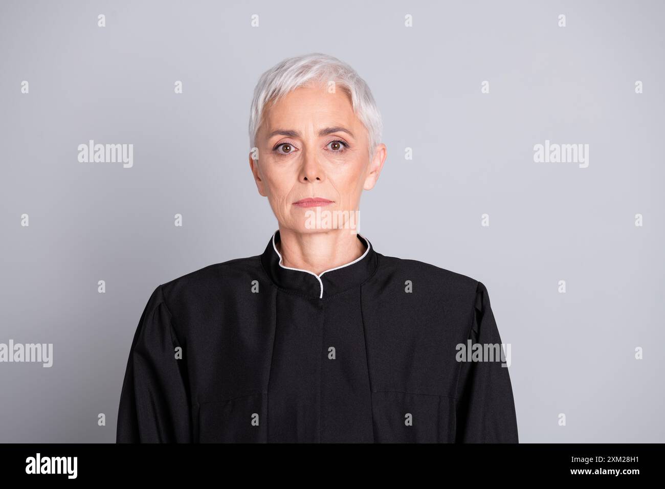 Photo of old retired woman in black robe judge look isolated grey color ...
