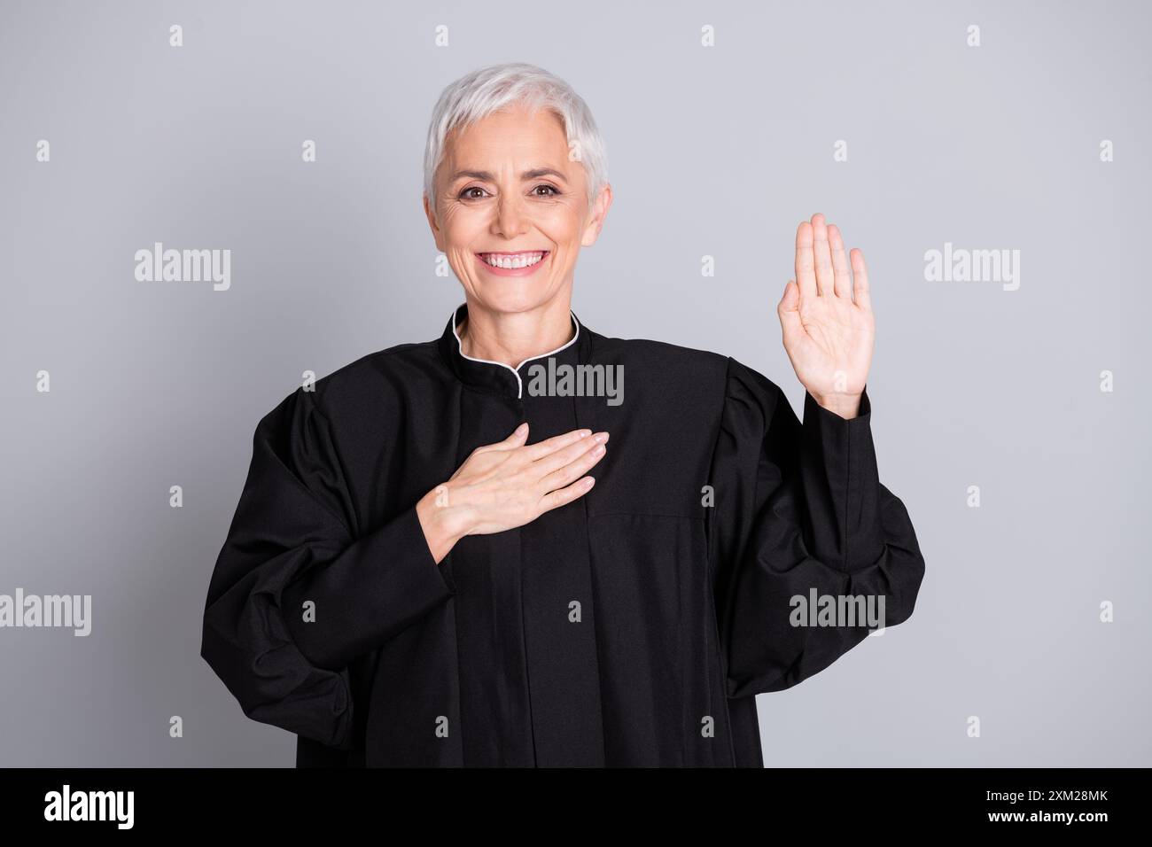 Photo of wise judge woman hold hands chest raise take oath in court ...