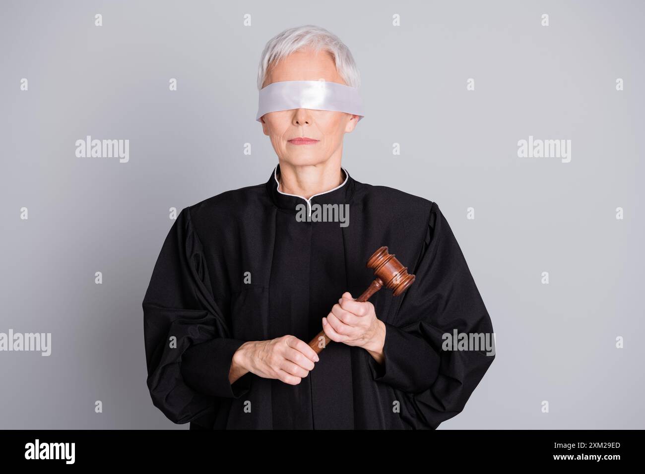 Photo of old serious woman judge with covered eyes hold wooden gavel ...