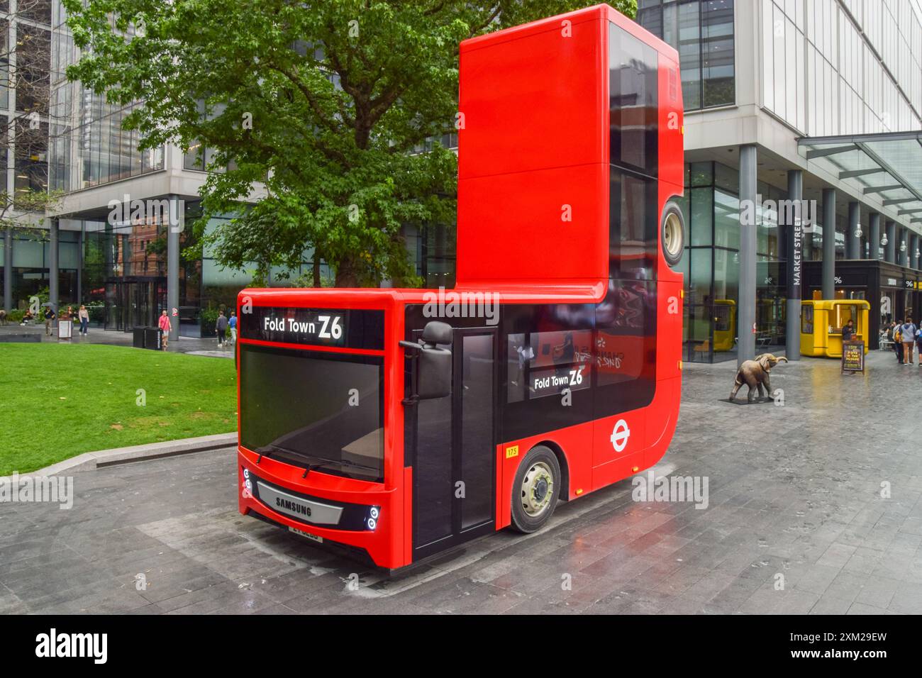 London, UK. 25th July 2024. A life-size folded bus at Spitalfields ...