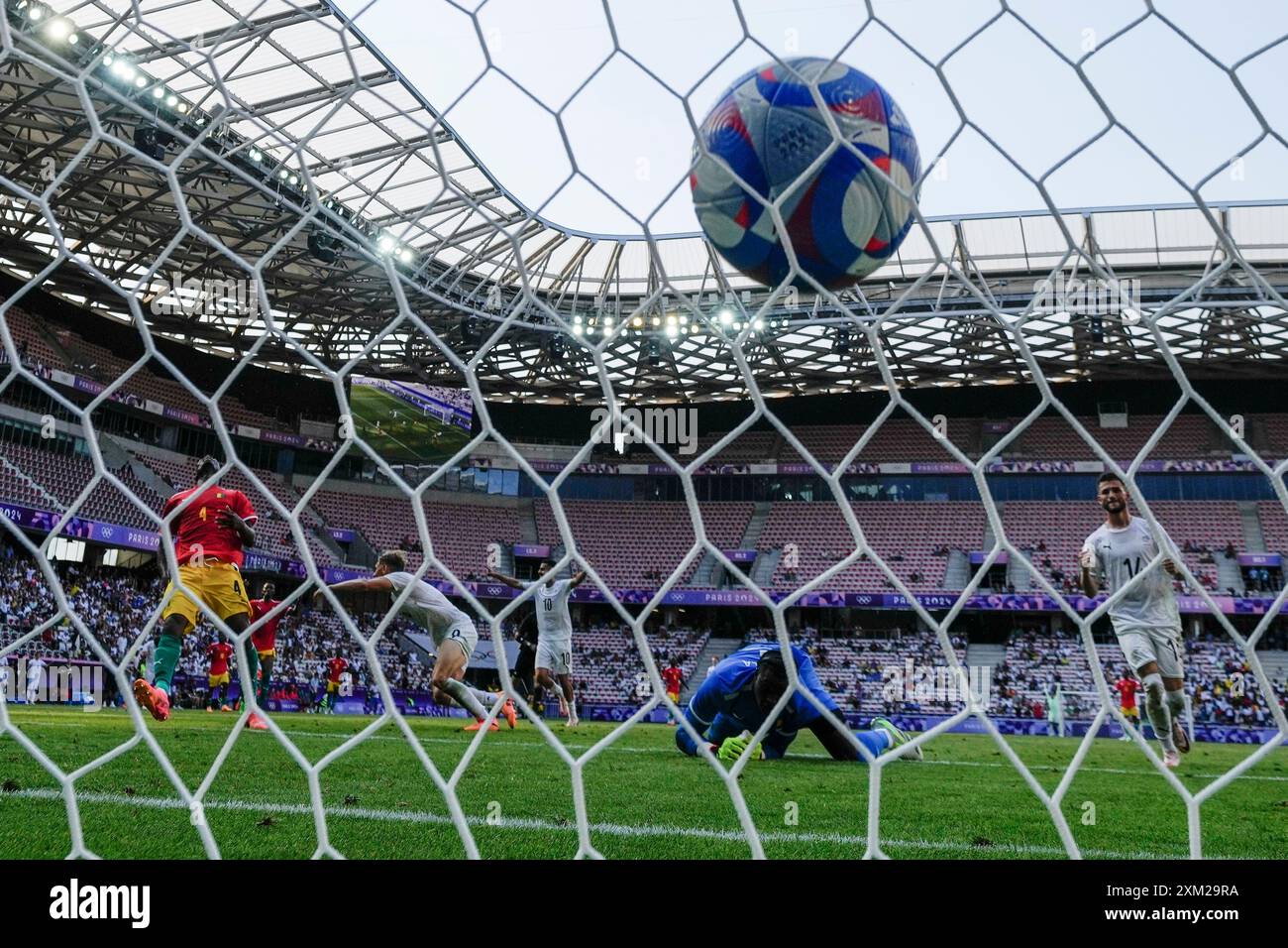 A shot by New Zealand's Ben Waine, second from left, entes the net of ...