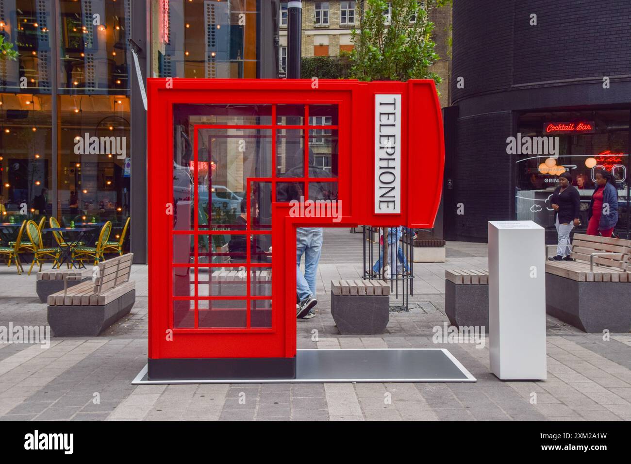 London, UK. 25th July 2024. A folded red telephone box in Old Street. A ...