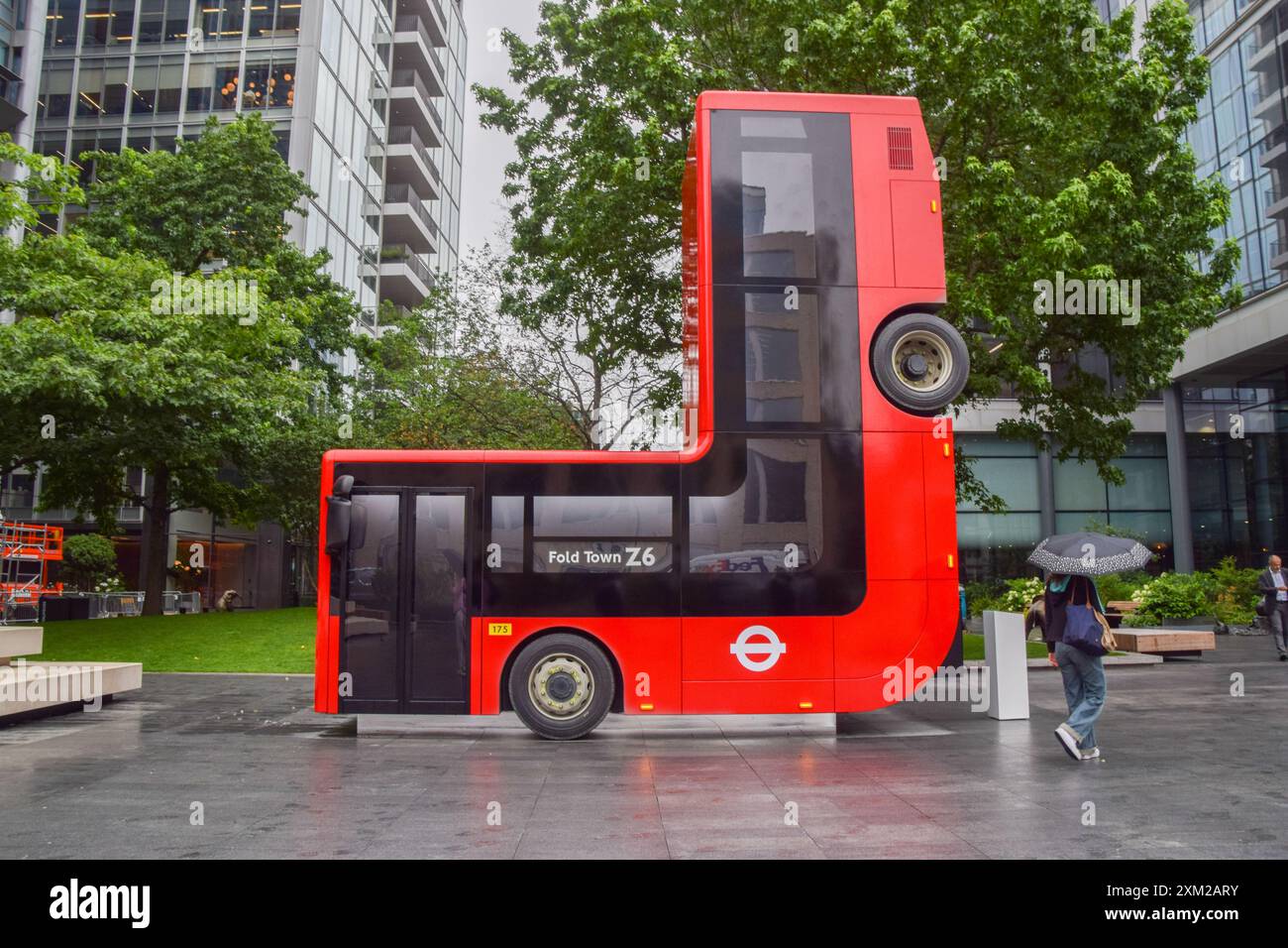 London, UK. 25th July 2024. A life-size folded bus at Spitalfields ...