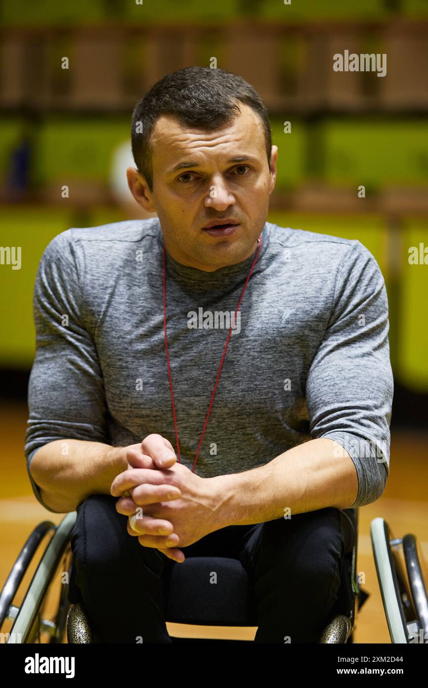 Coach of adaptive basketball team players. Paralyzed athlete in a ...