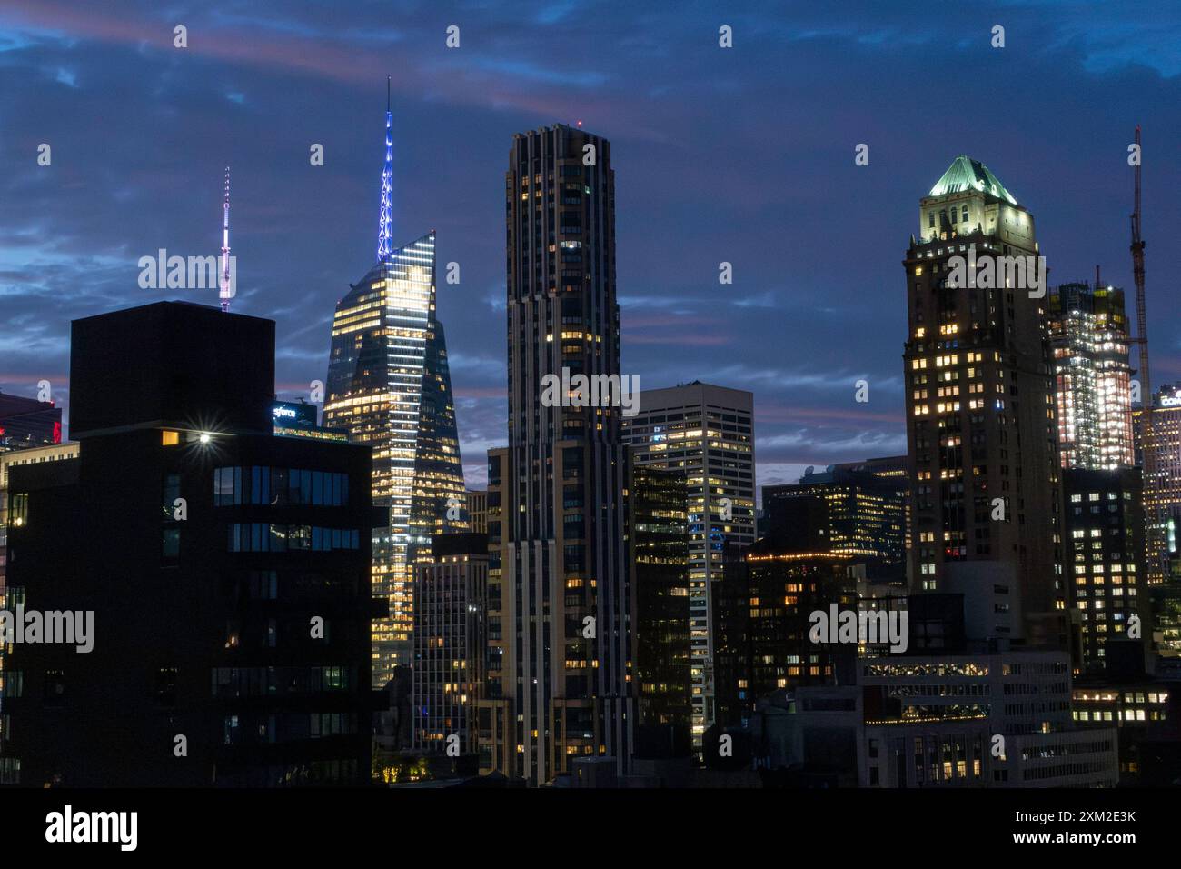 Midtown Manhattan skyline brightly lit at dusk on summer night, 2024 ...