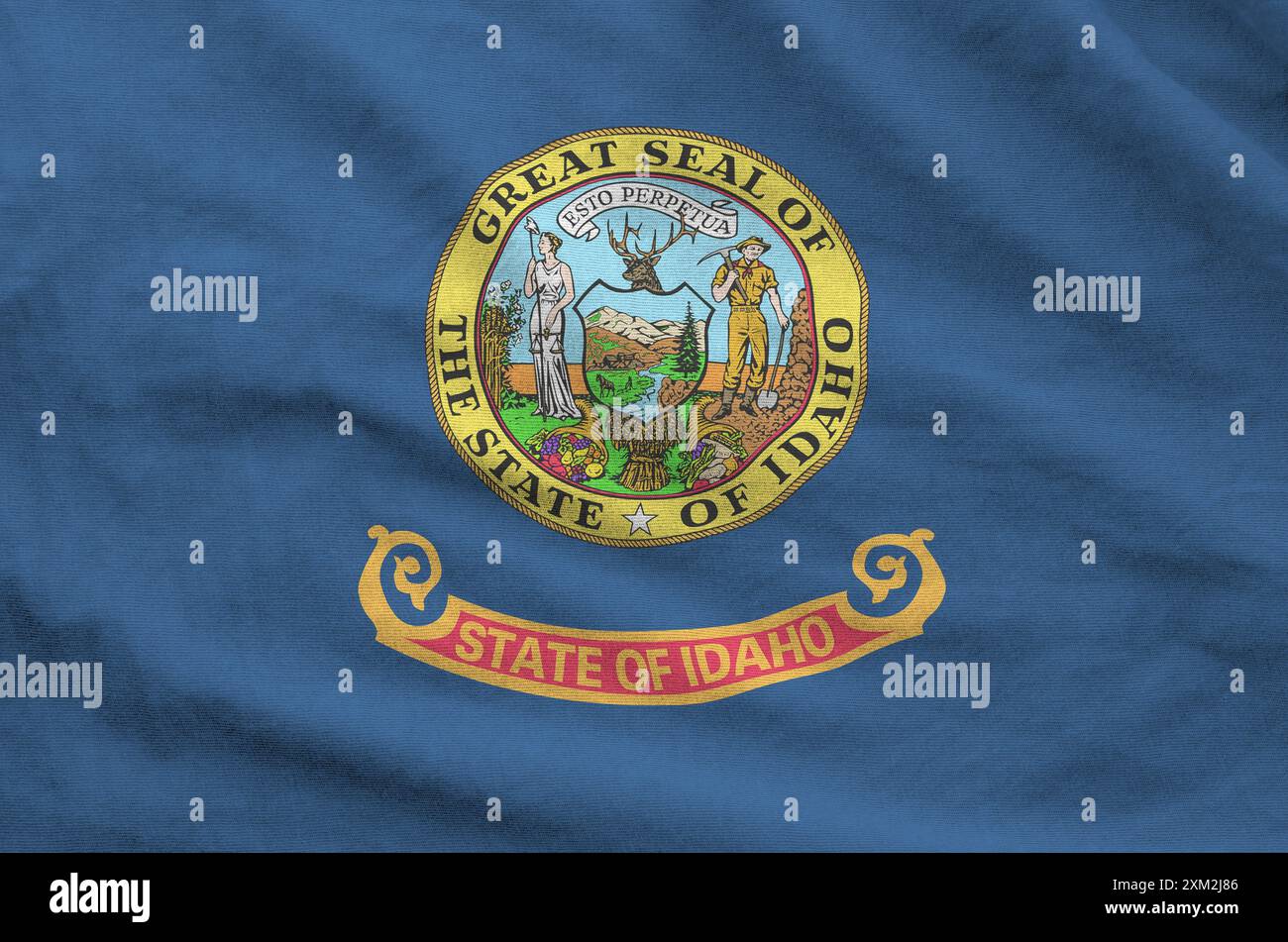 Idaho US state flag depicted on folded wavy fabric of old cloth close ...