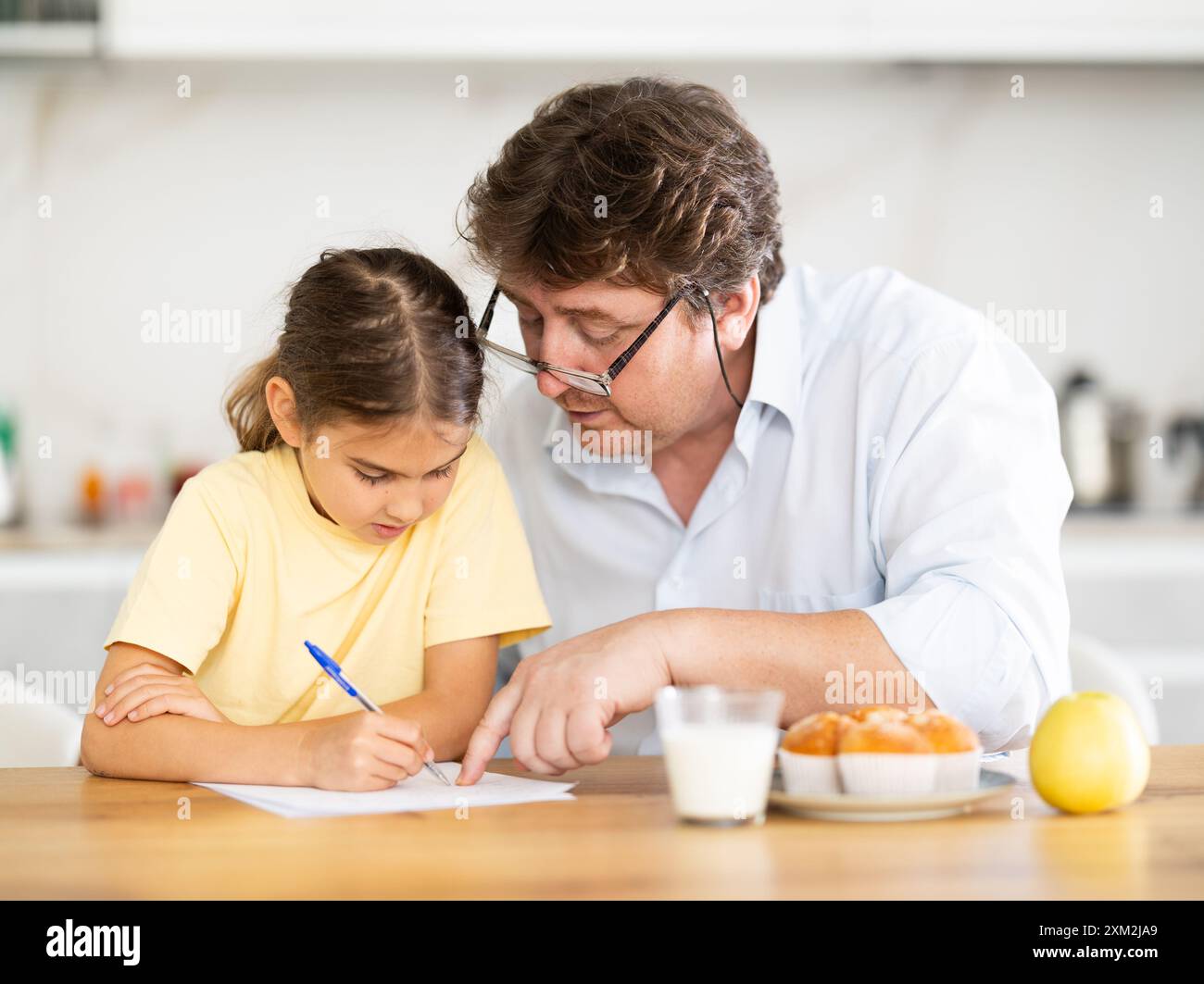 Father helping his daughter do her homework Stock Photo - Alamy