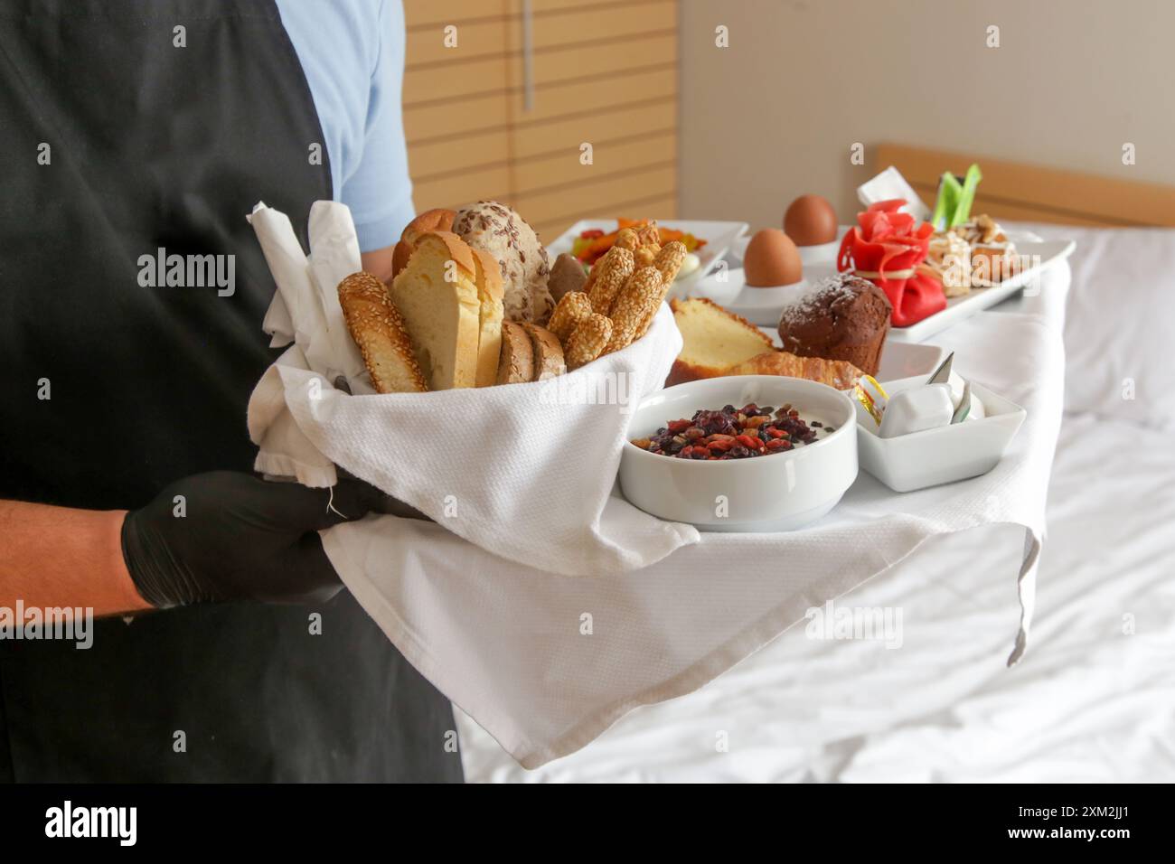 Room service hotel staff carries breakfast tray Stock Photo - Alamy