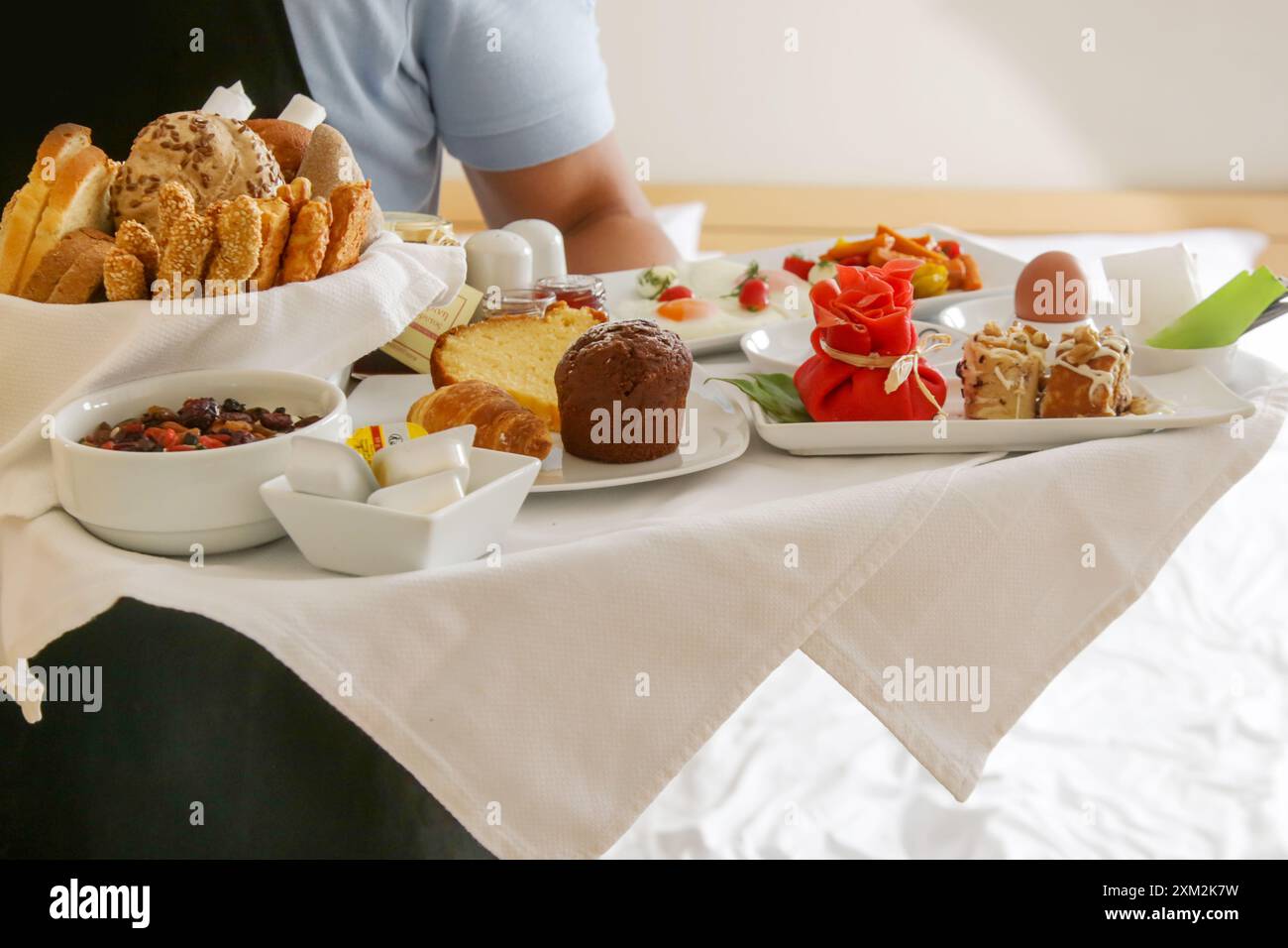 Room service hotel staff carries breakfast tray Stock Photo - Alamy