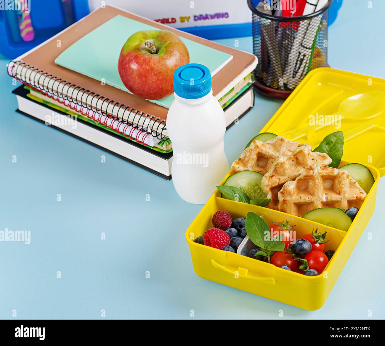 Kids lunch box with zucchini waffles, cucumber, cherry tomatoes and ...